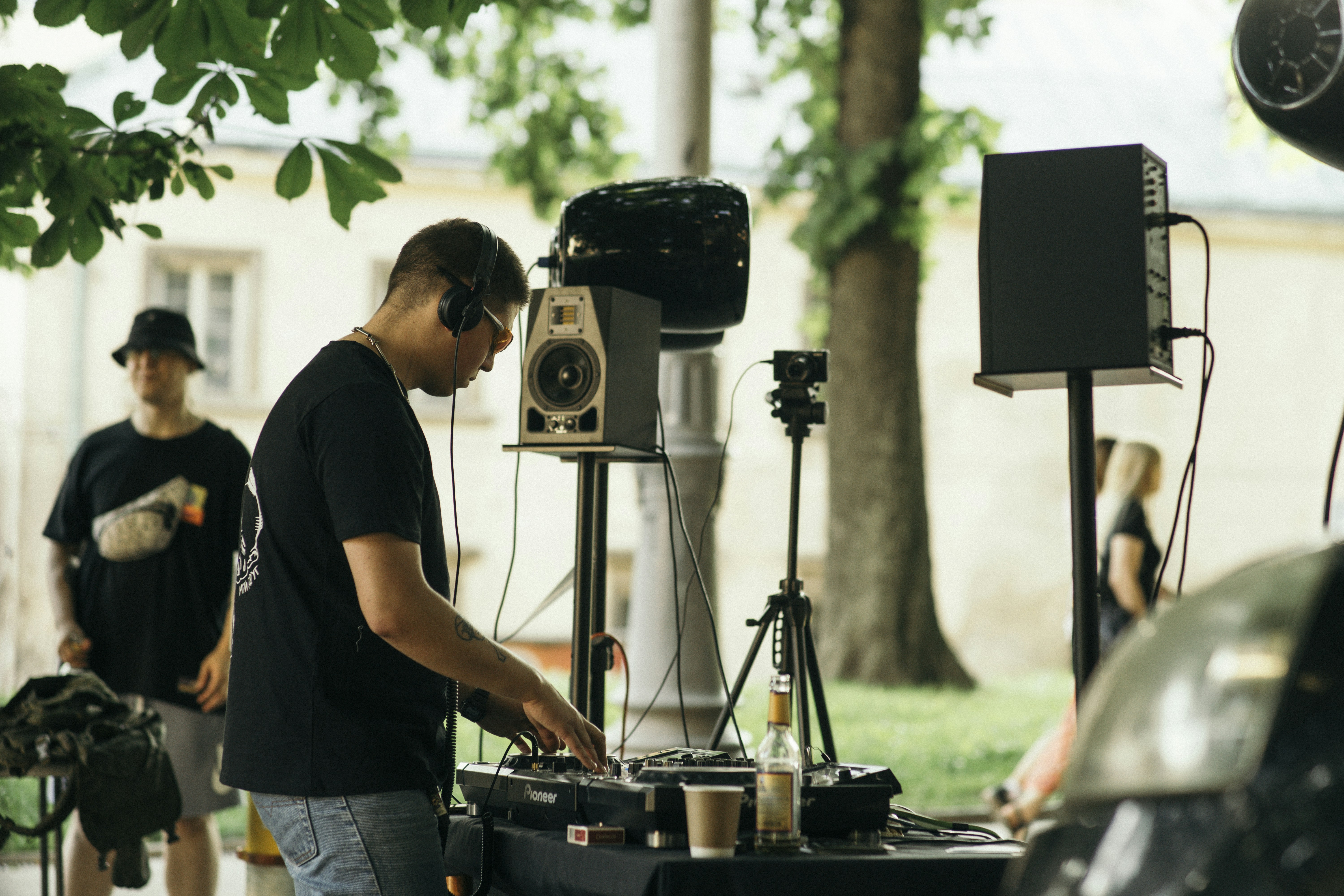 A man standing in front of a camera and recording equipment photo ...