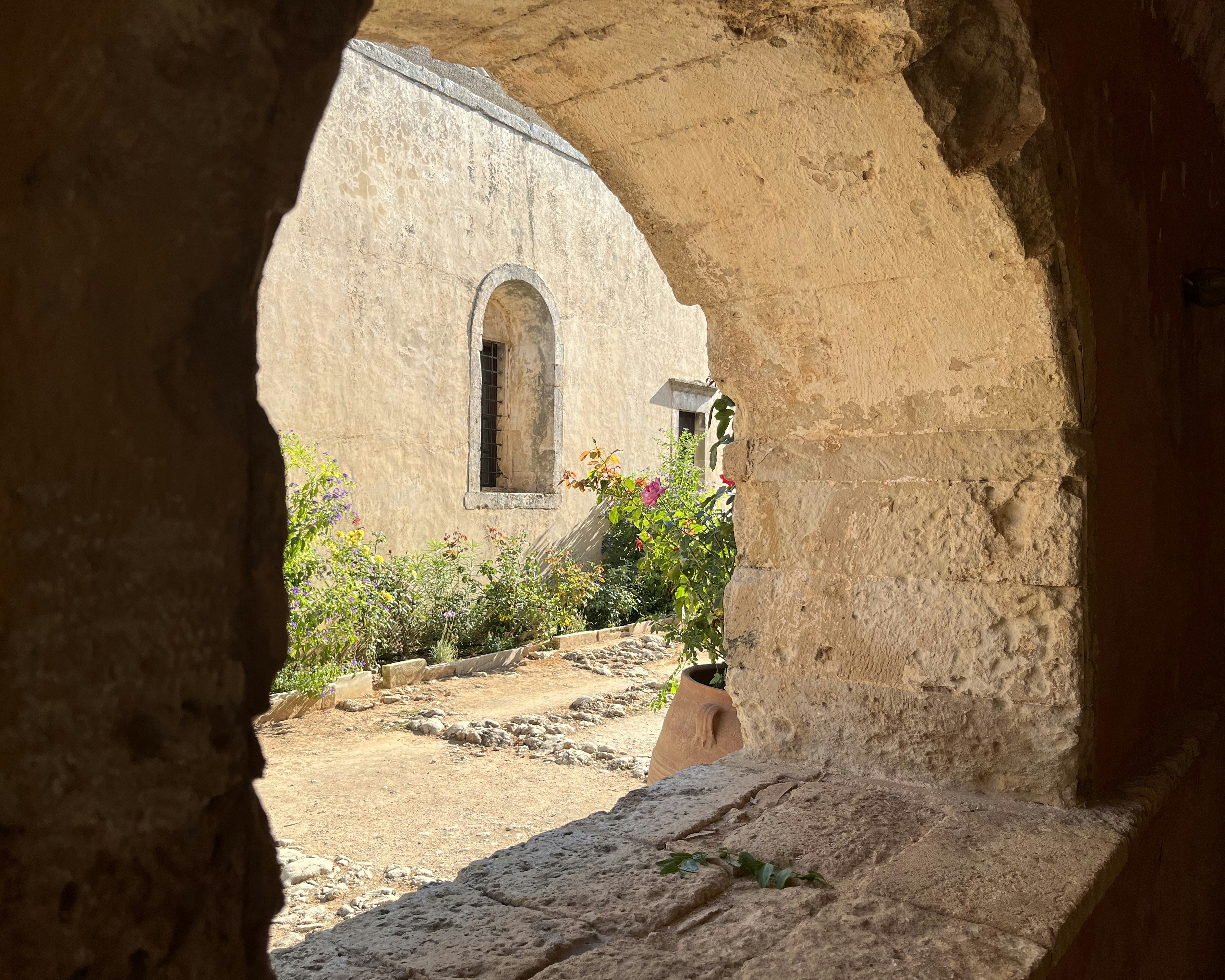 A view of a building through a stone archway photo – Free Arkadi Image ...