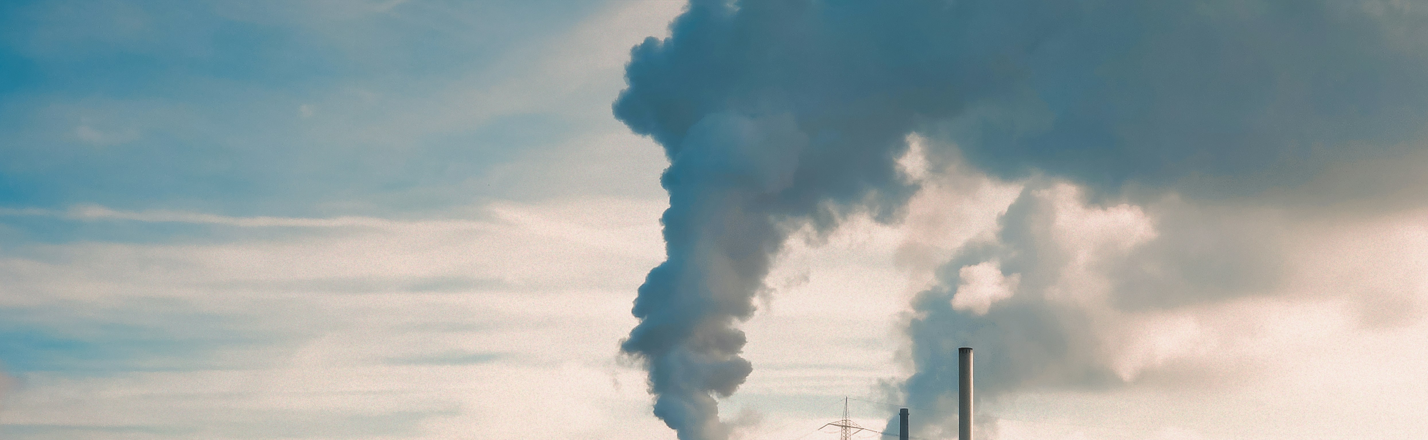 A factory with smoke coming out of it's stacks photo – Free Germany ...