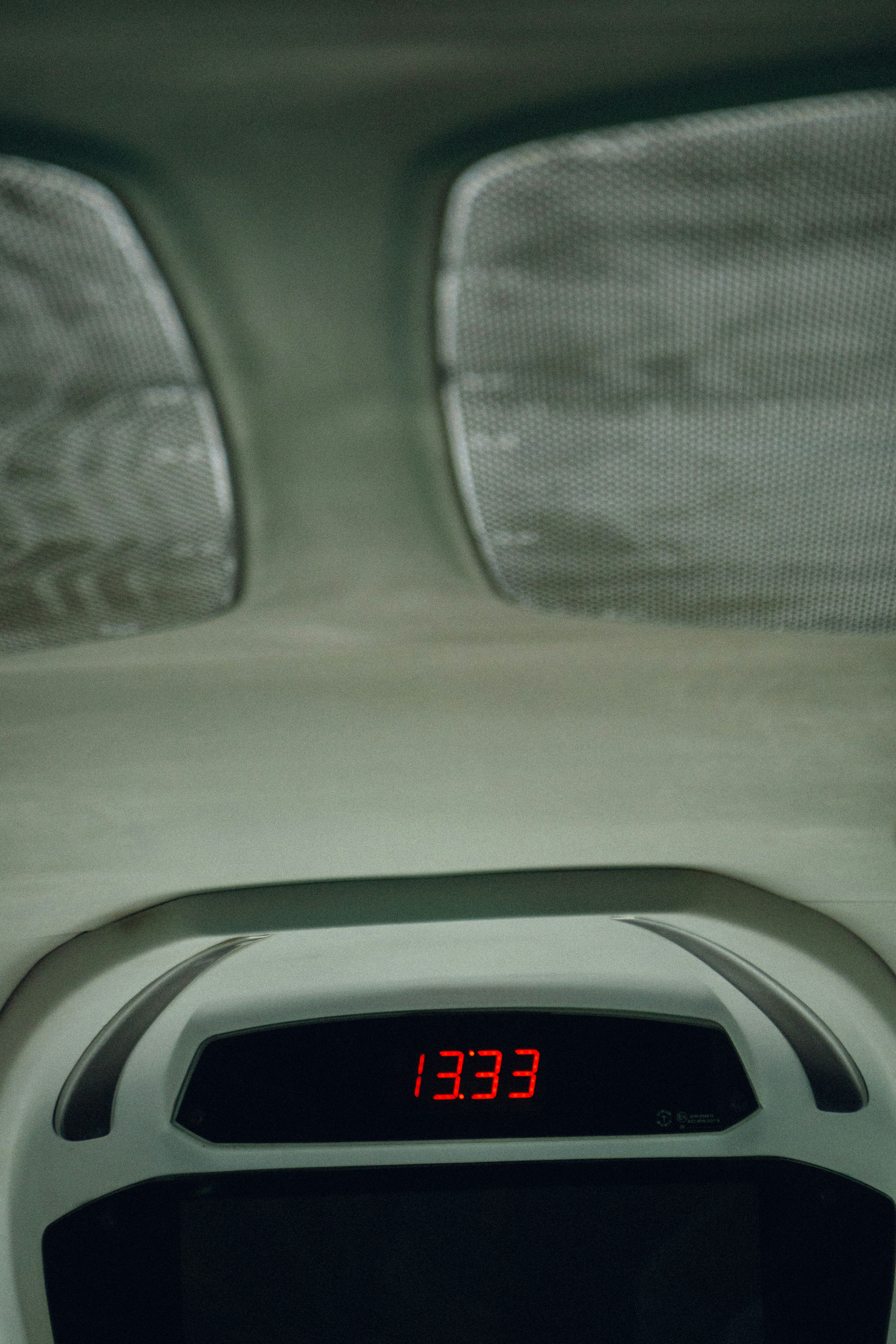 Dashboard Pulse: Red 13:33 LED Clock in a Quiet Car Cabin