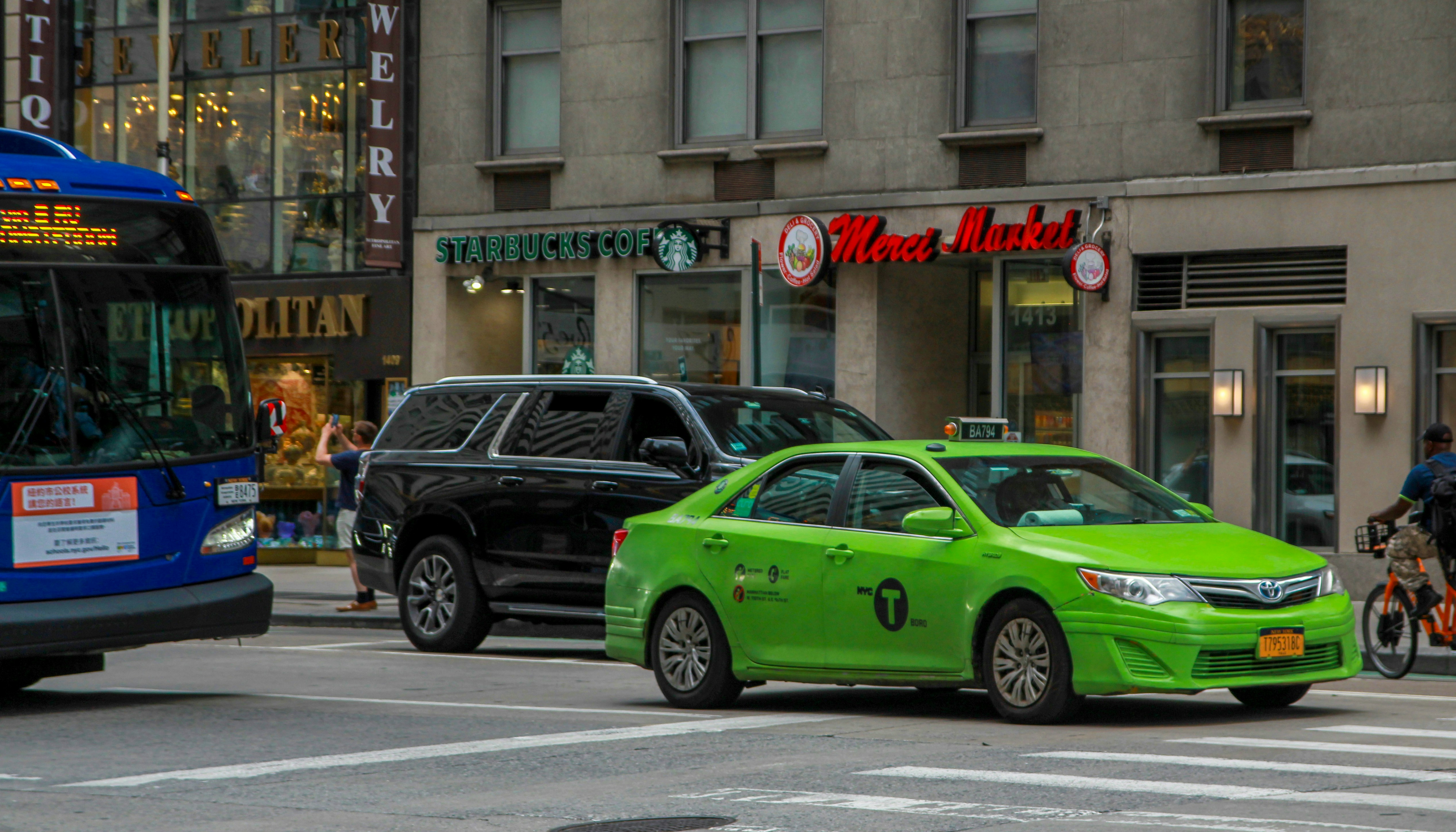 Emerald Taxi at the Crosswalk: A City Street in Motion