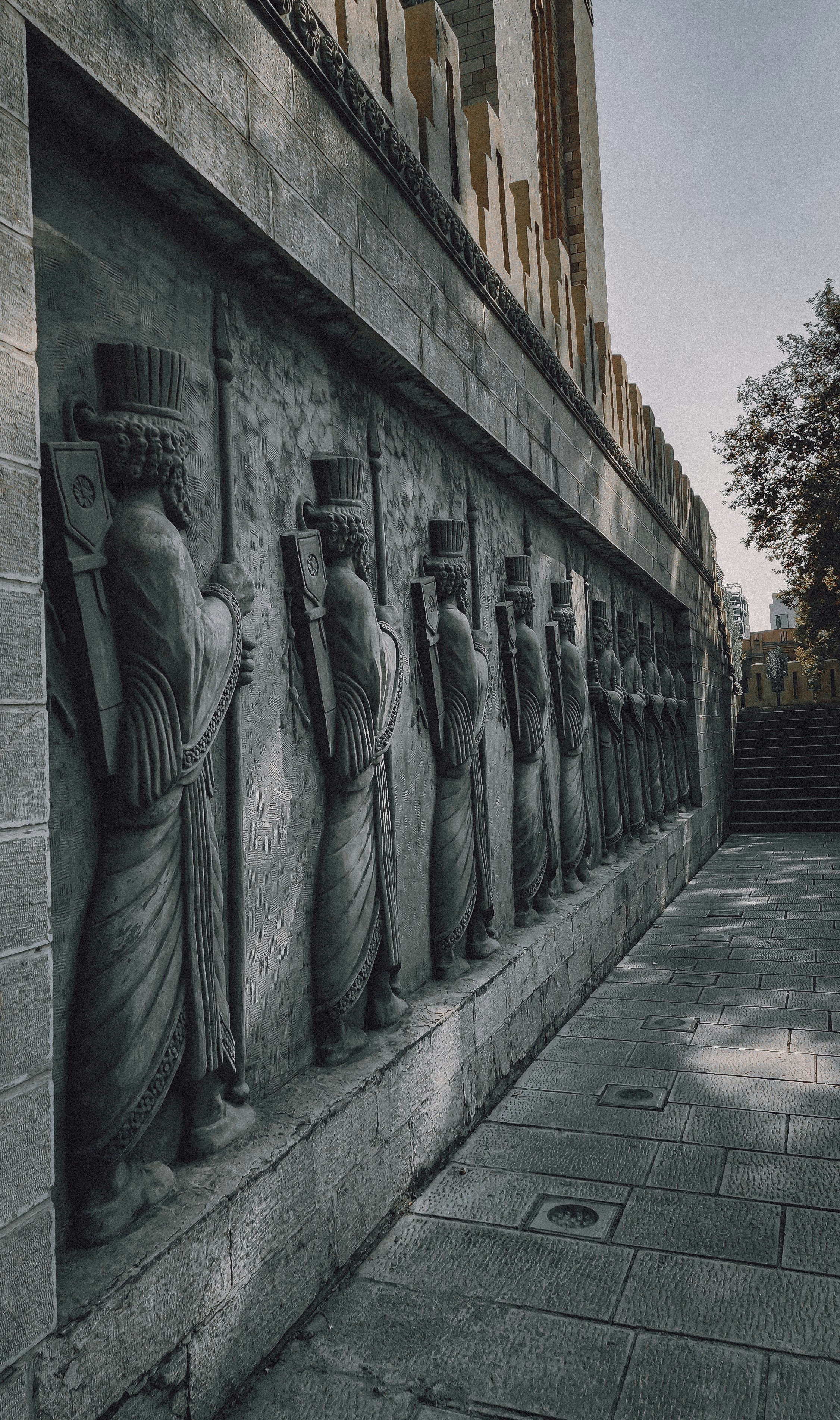 A row of statues on the side of a building photo – Free Tehran province ...