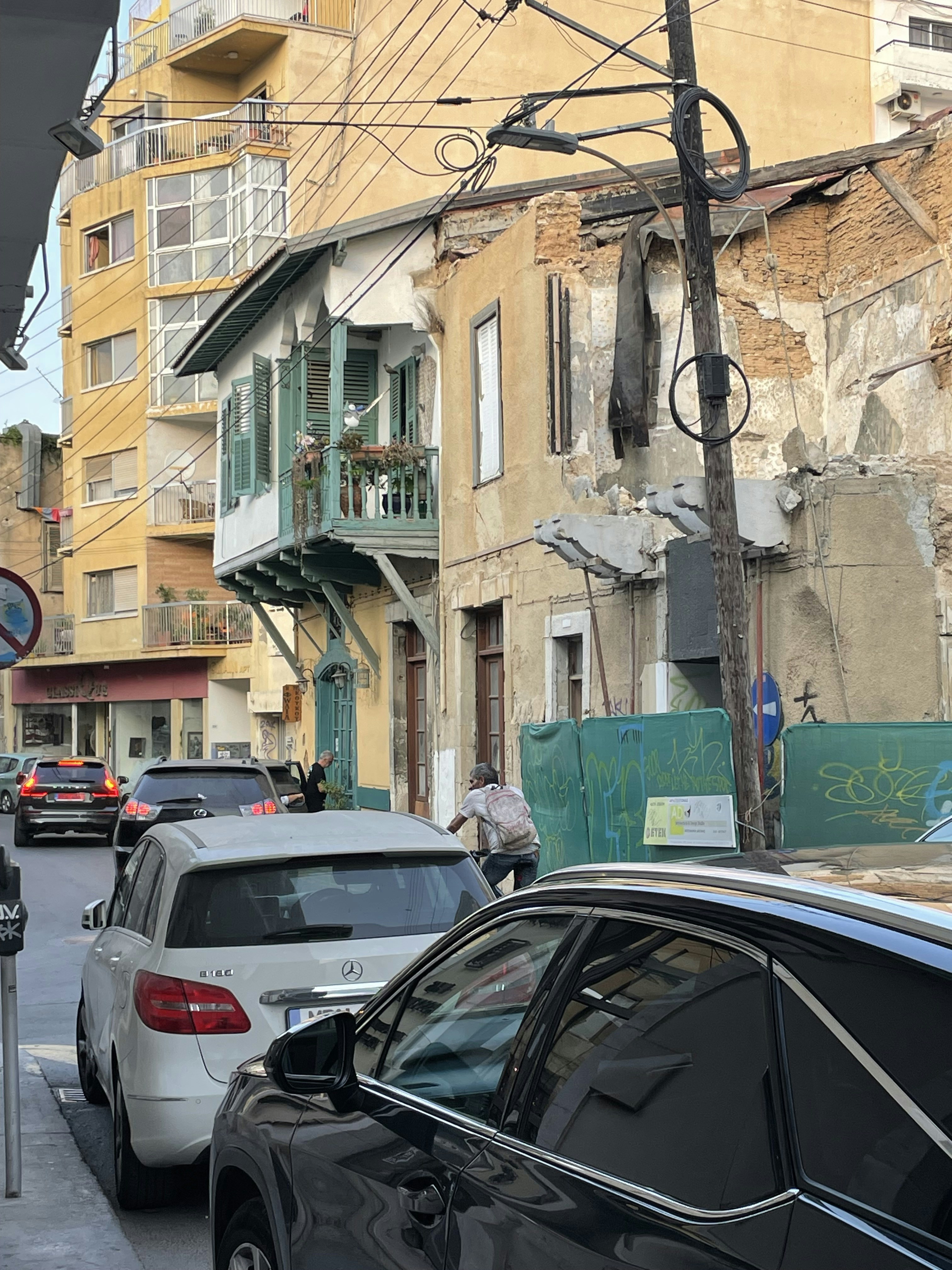 Cracked Facade Over a Lively Street Corridor