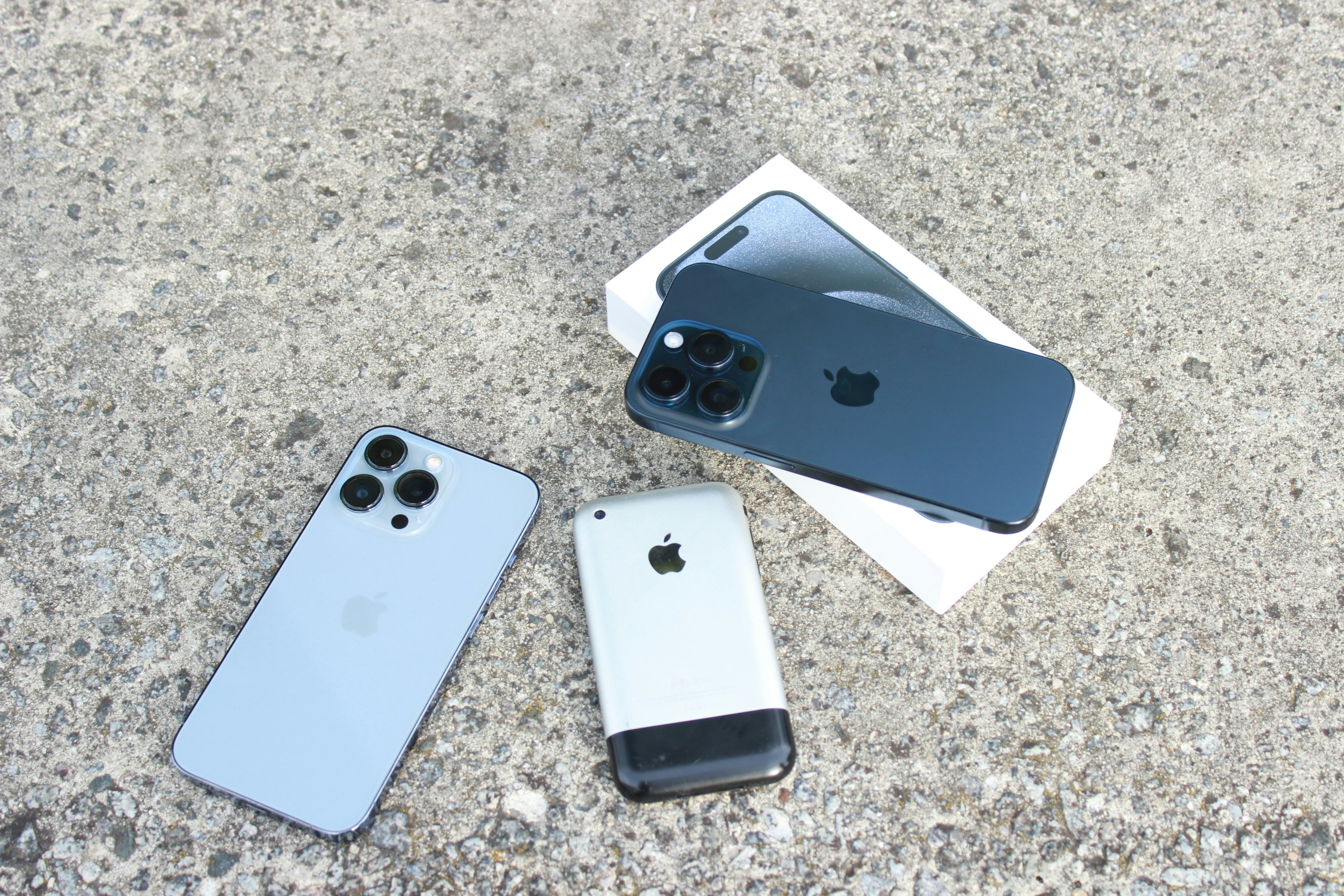 Three iphones sitting on the ground next to each other photo – Free ...