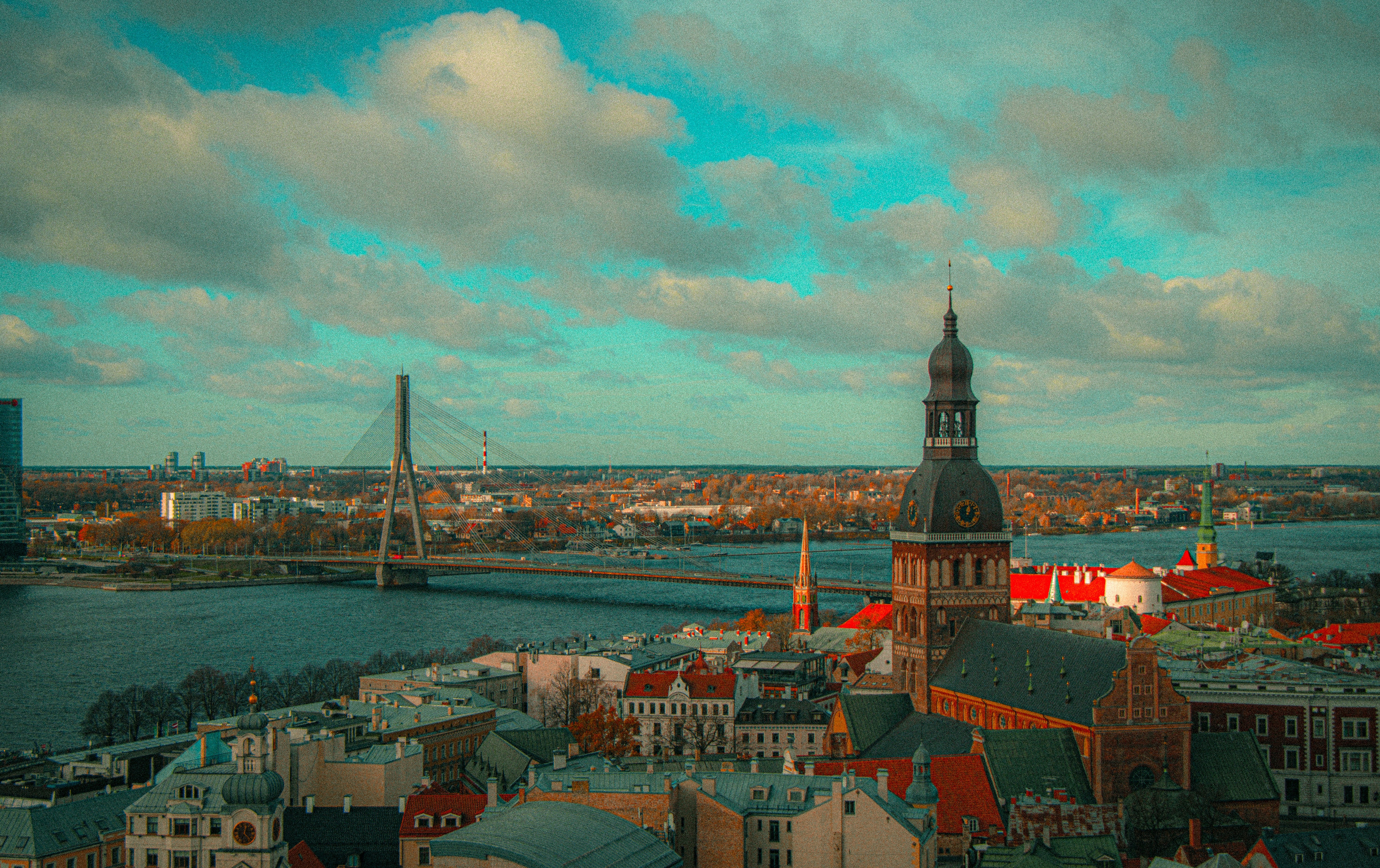 A view of a city with a bridge in the background photo – Free Riga ...