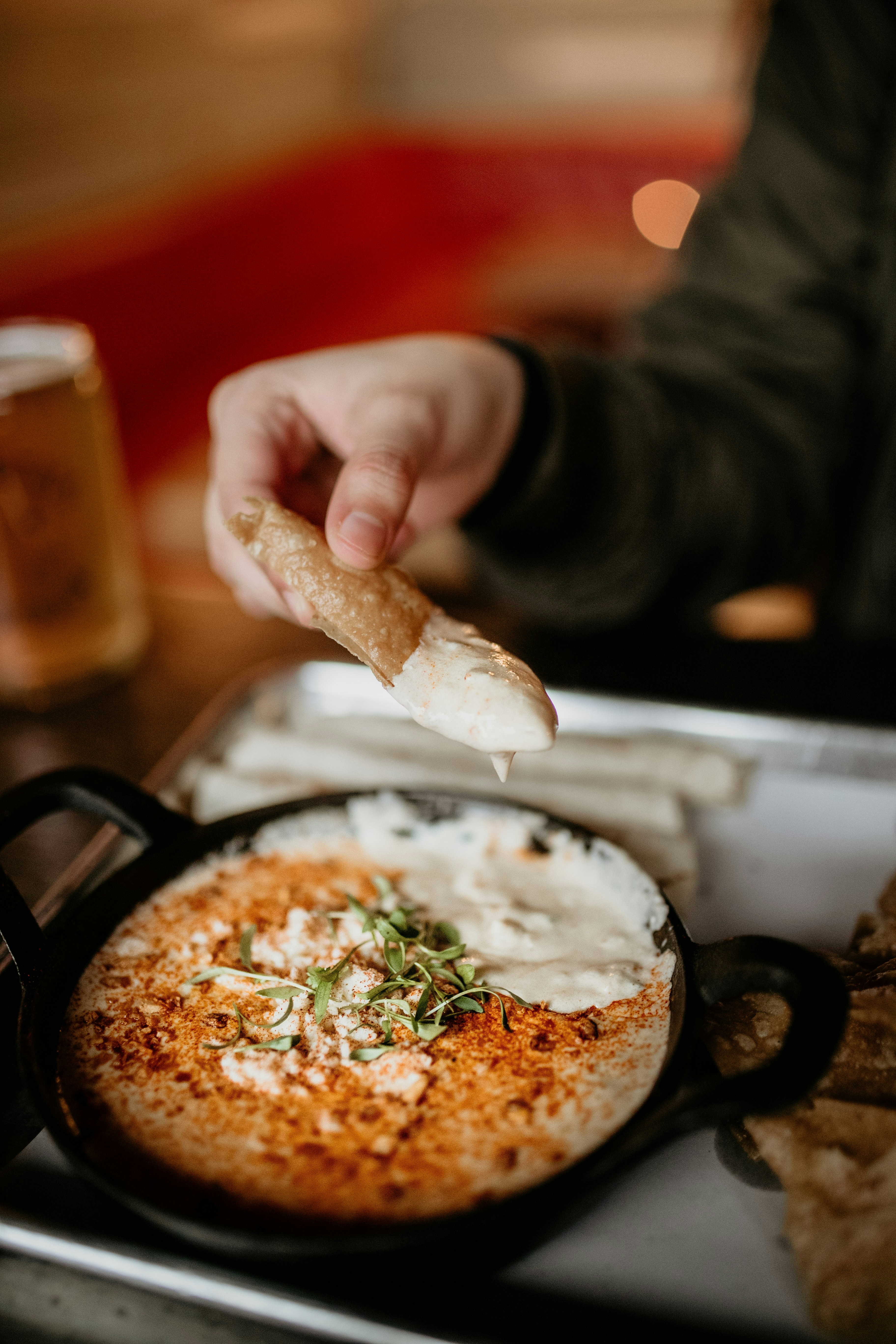 man eating mexican queso appetizer