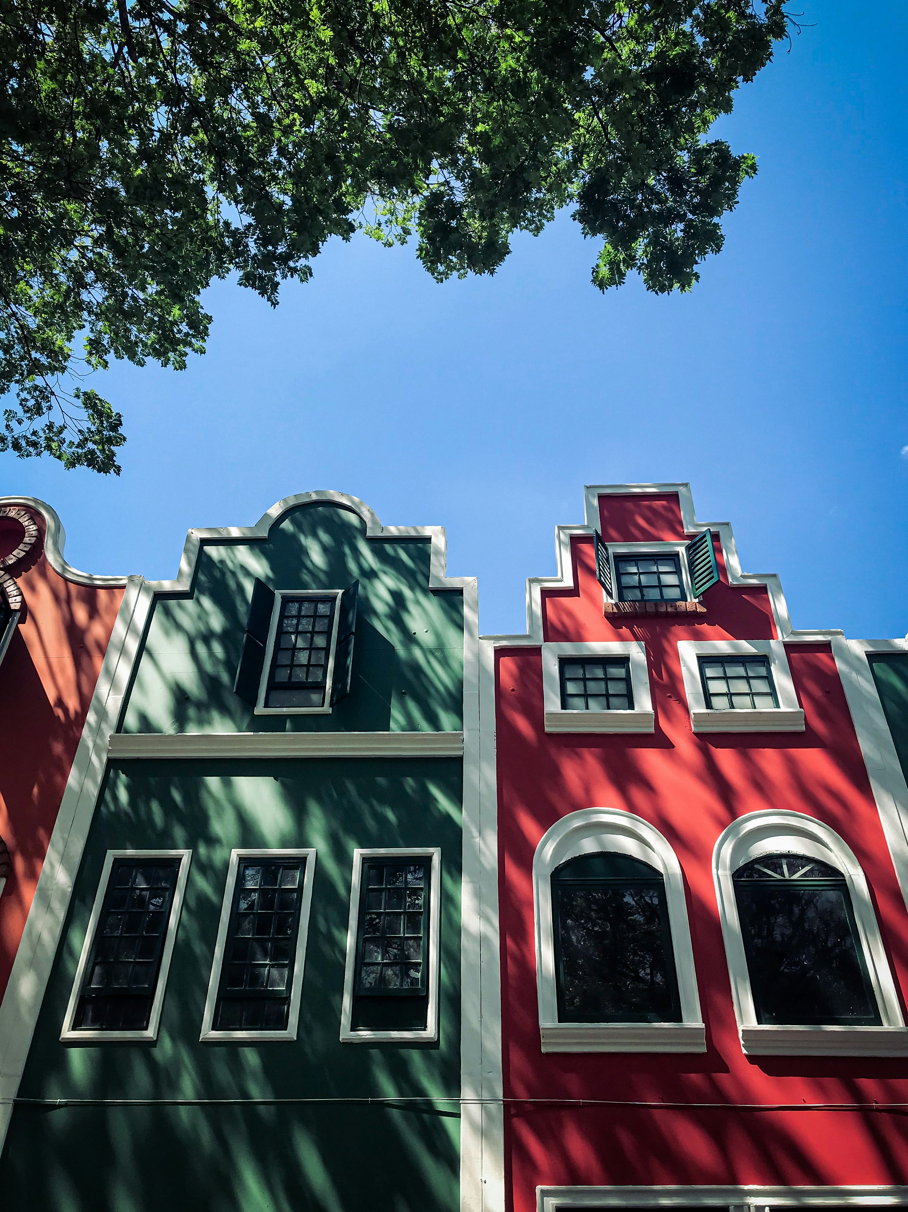 Noon-Light Gables: Green and Crimson Facades with White Trim