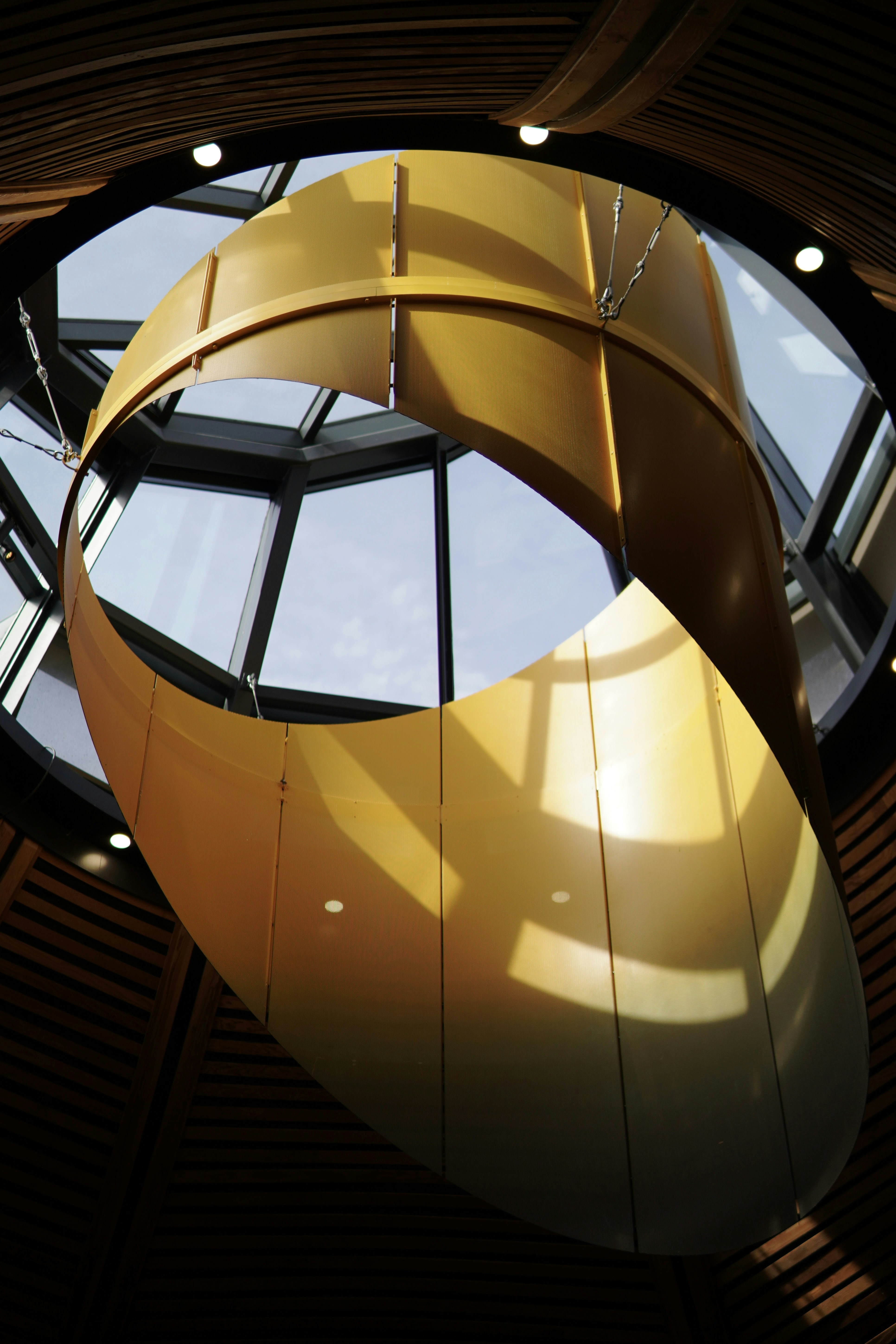 A large circular window in the ceiling of a building photo – Free ...