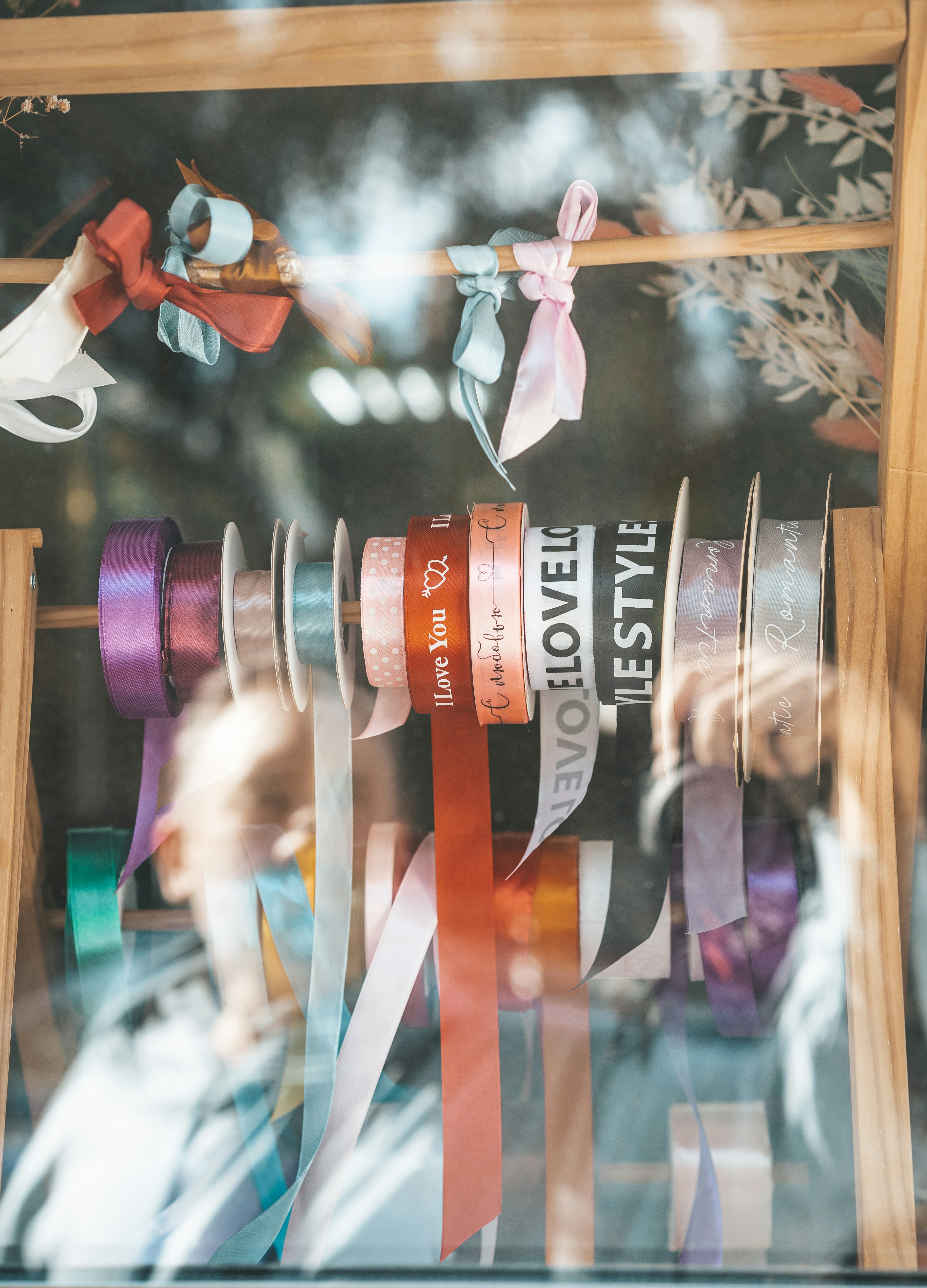 A bunch of ribbons hanging in a window photo – Free Street Image on ...