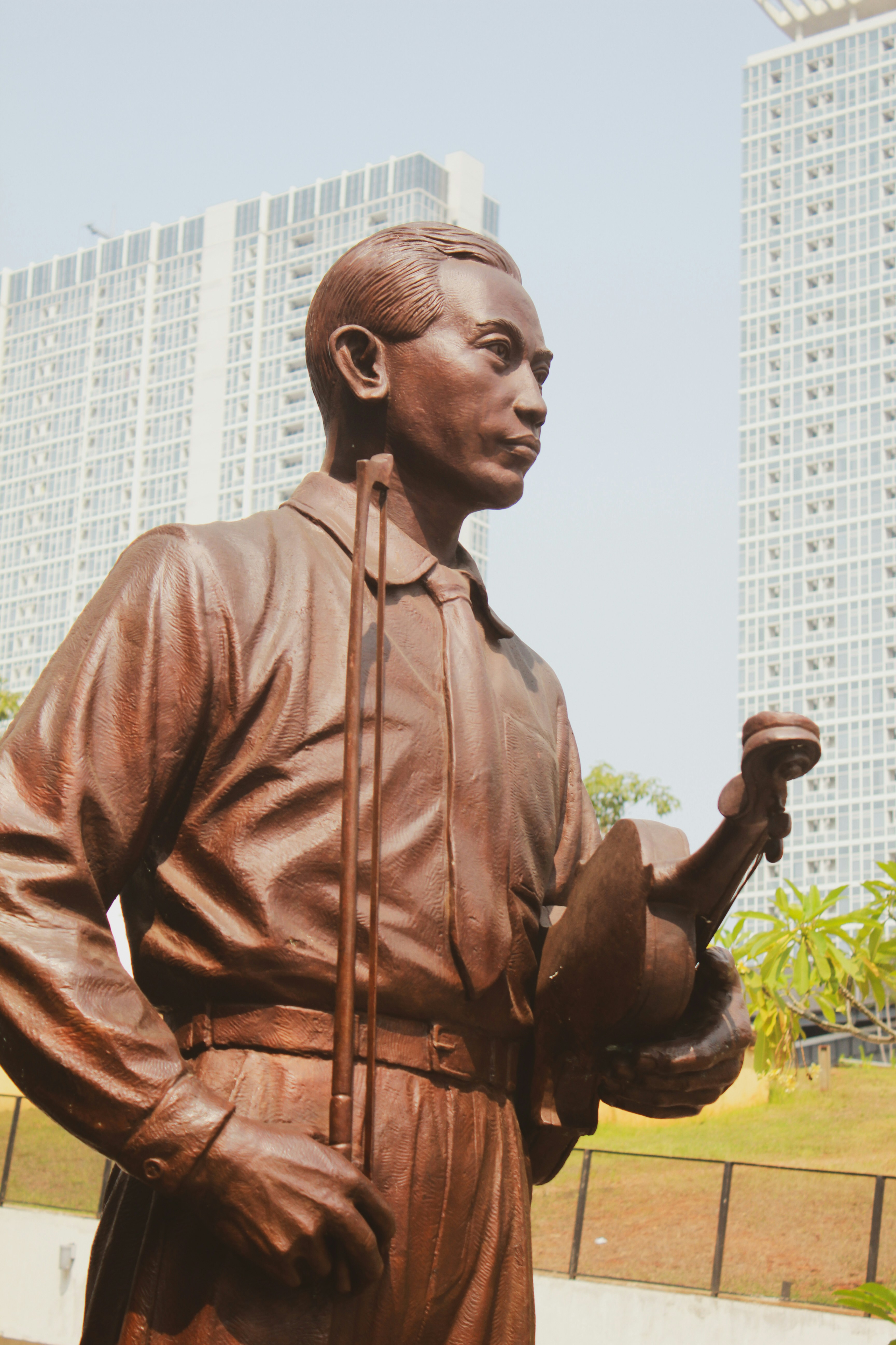 Bronze Portrait Amid Glass Skyscrapers