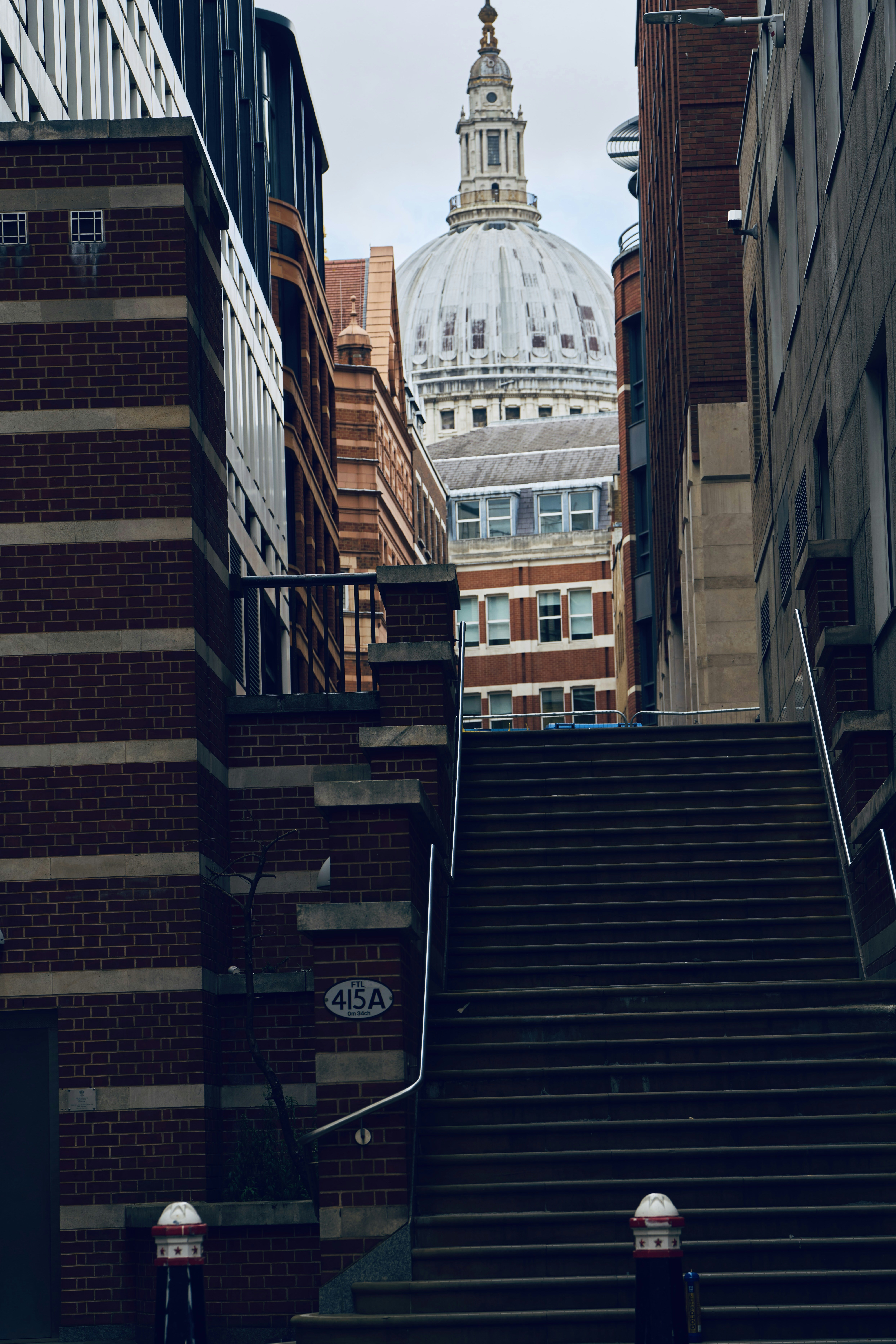Urban Ascent: Brick Staircase Framing a Grand City Dome