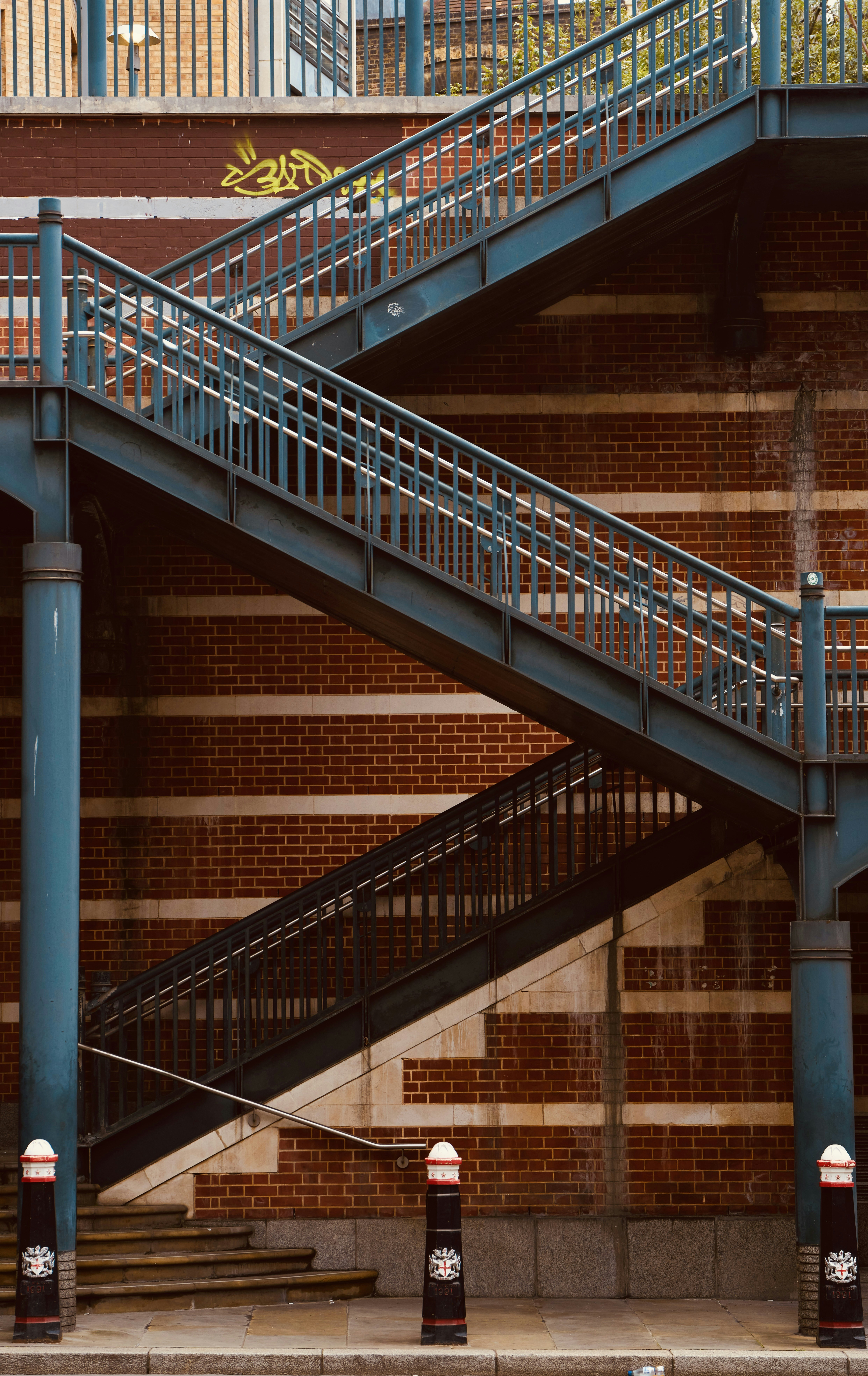 A fire hydrant in front of a brick building photo – Free Building Image ...