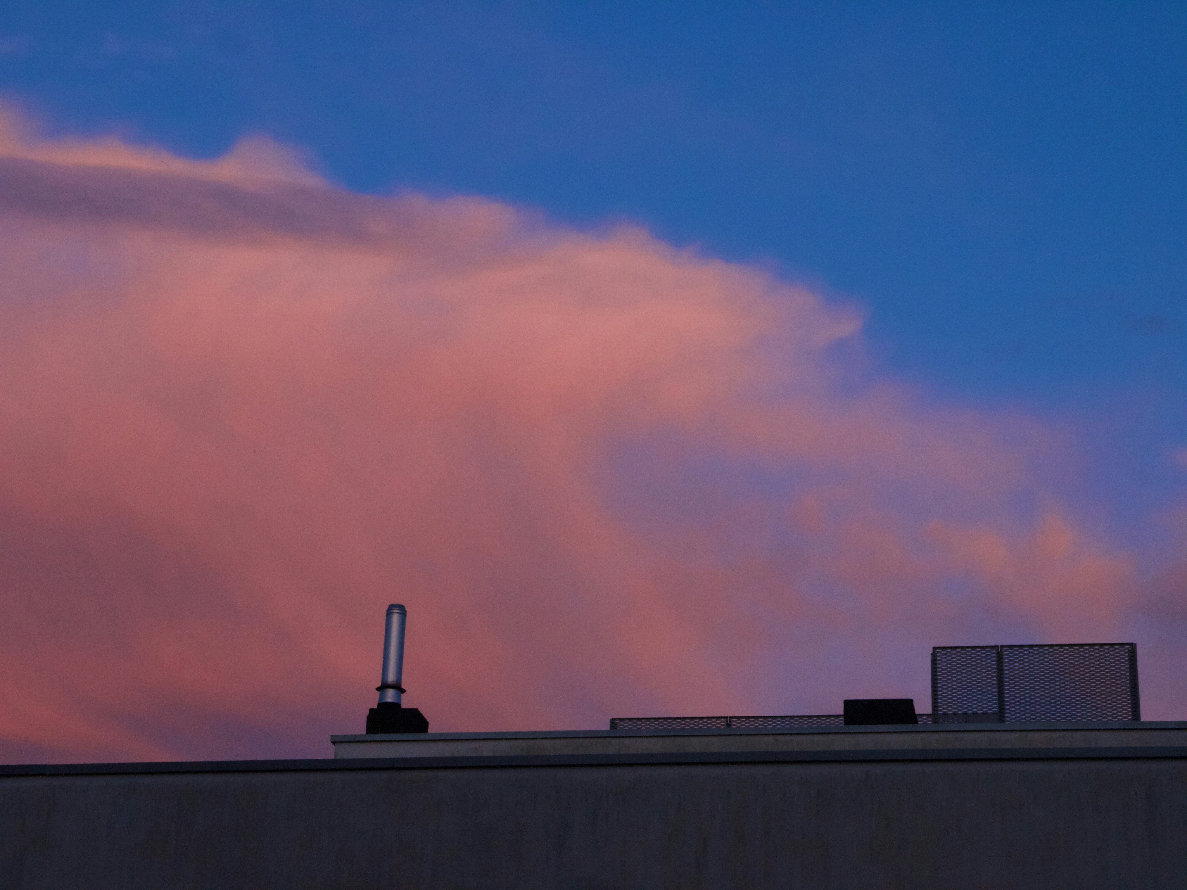 Rooftop Sentinel Under a Coral-Blue Twilight