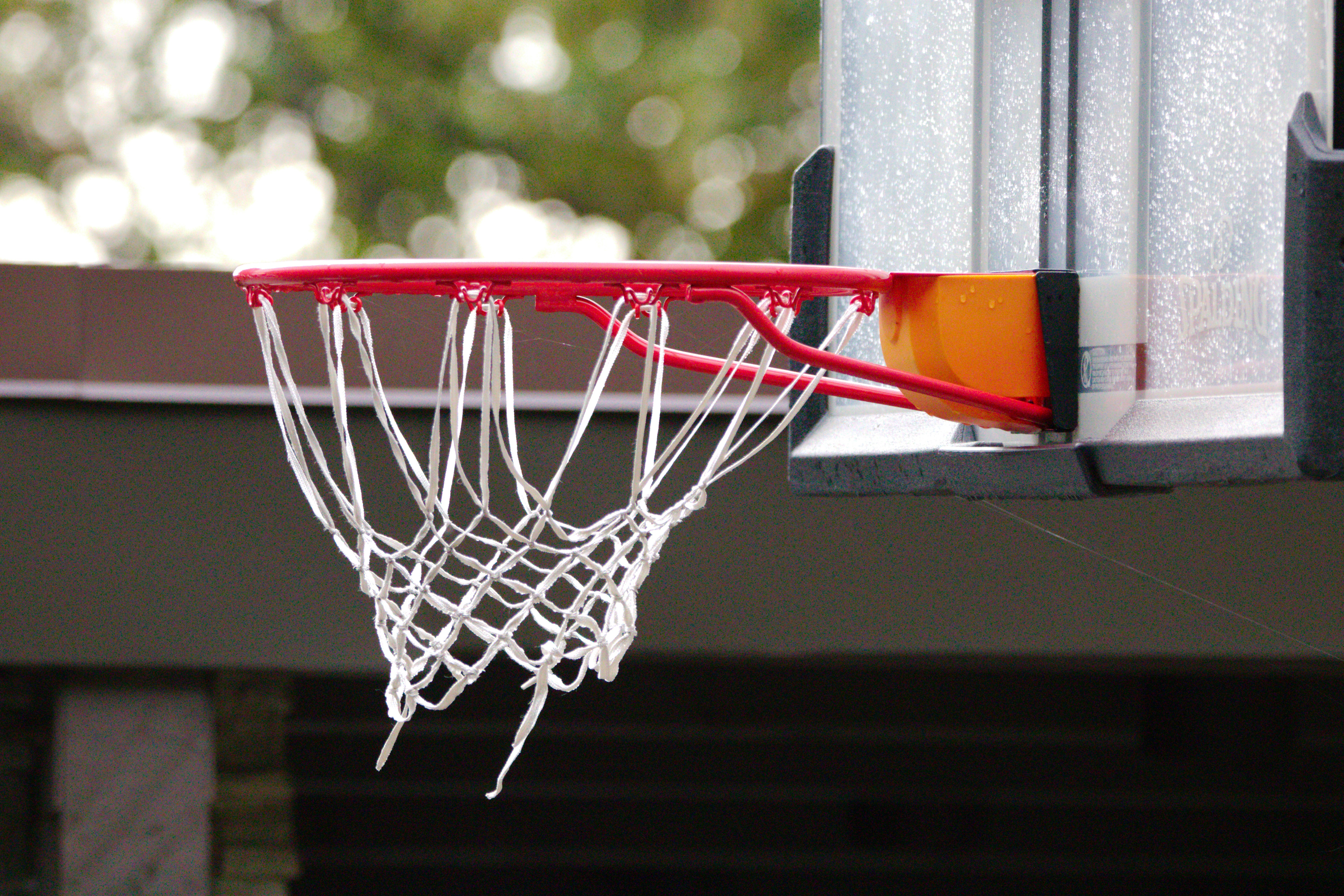 A close up of a basketball going through the net photo – Free Street ...