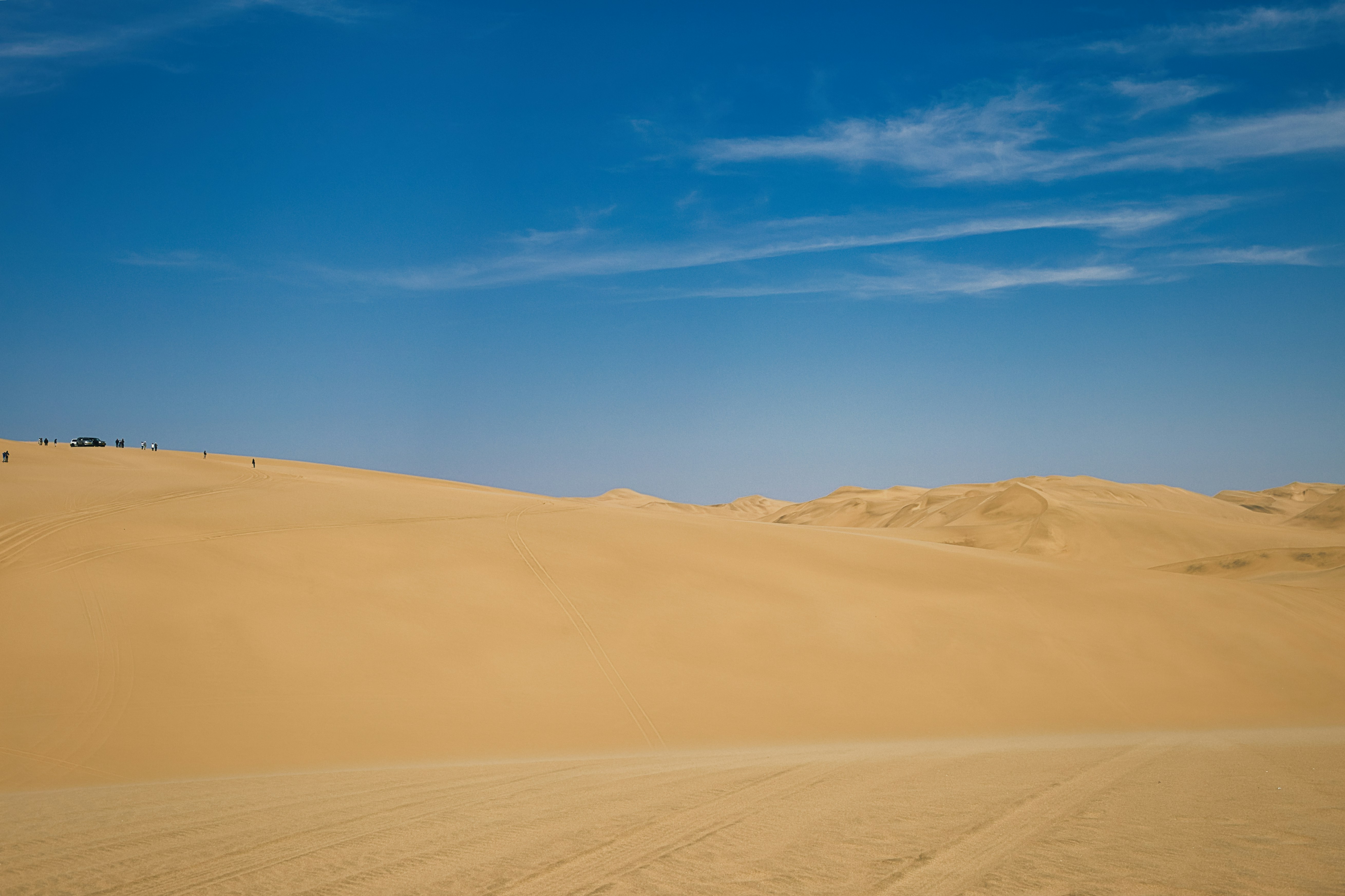 A group of people walking across a sandy field photo – Free Namibia ...
