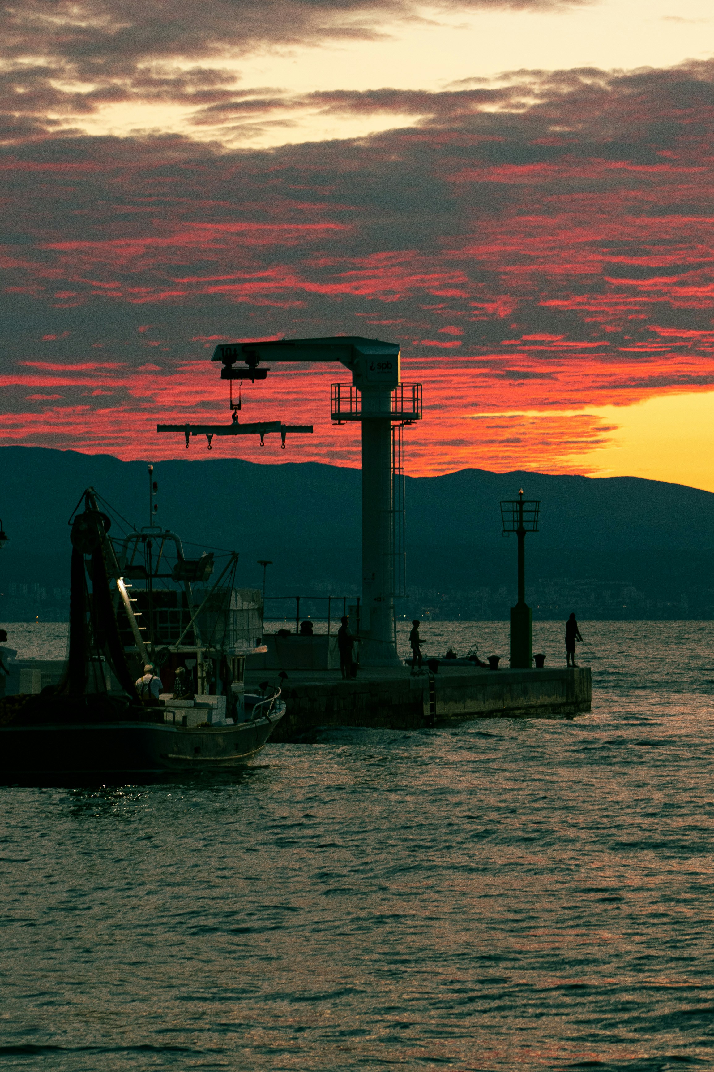 Gantry at Sunset: Silhouette of a Harbor Crane Against a Fiery Sky