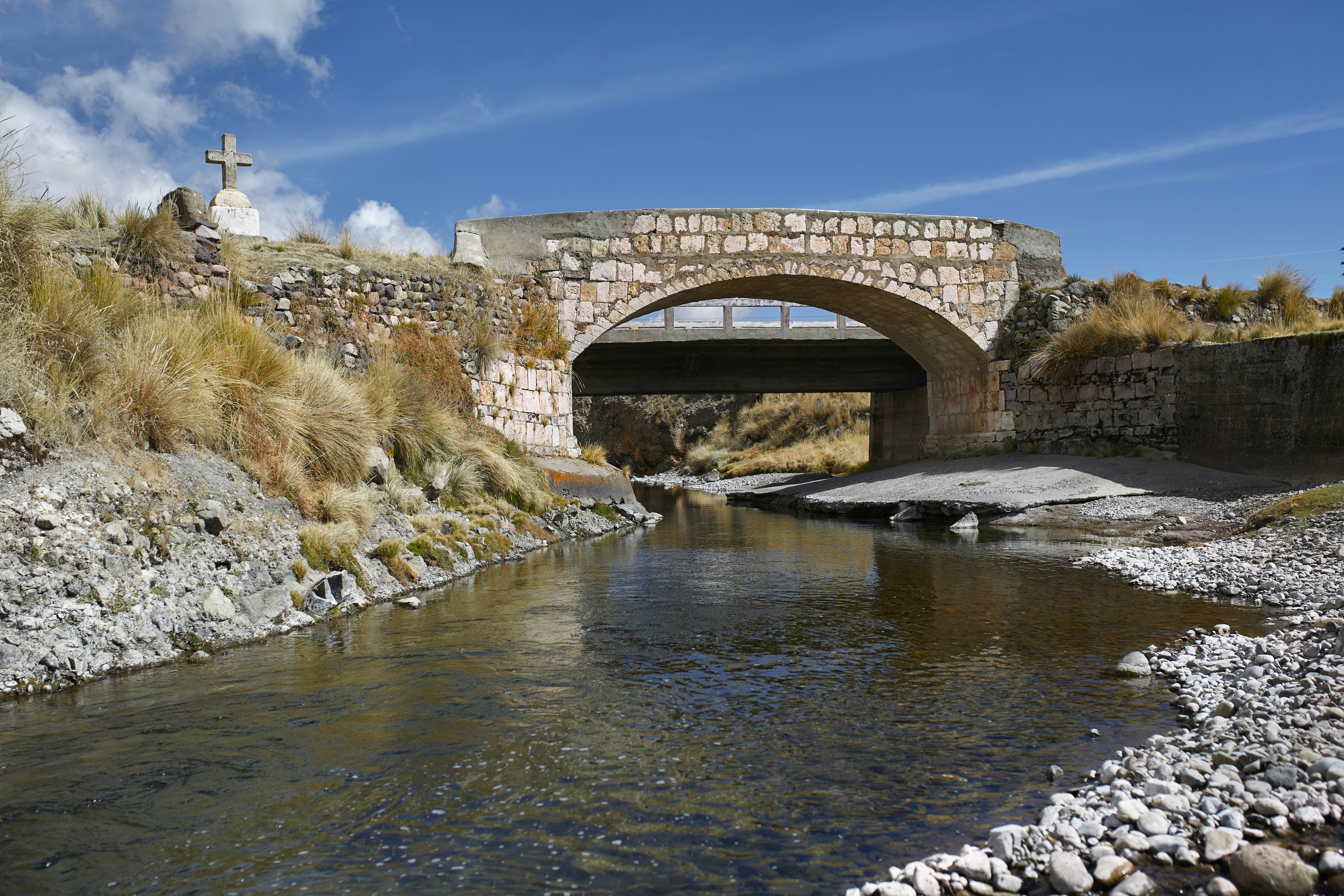 Stone Arch and Gentle River: A Quiet Bridge over a Shallow Channel
