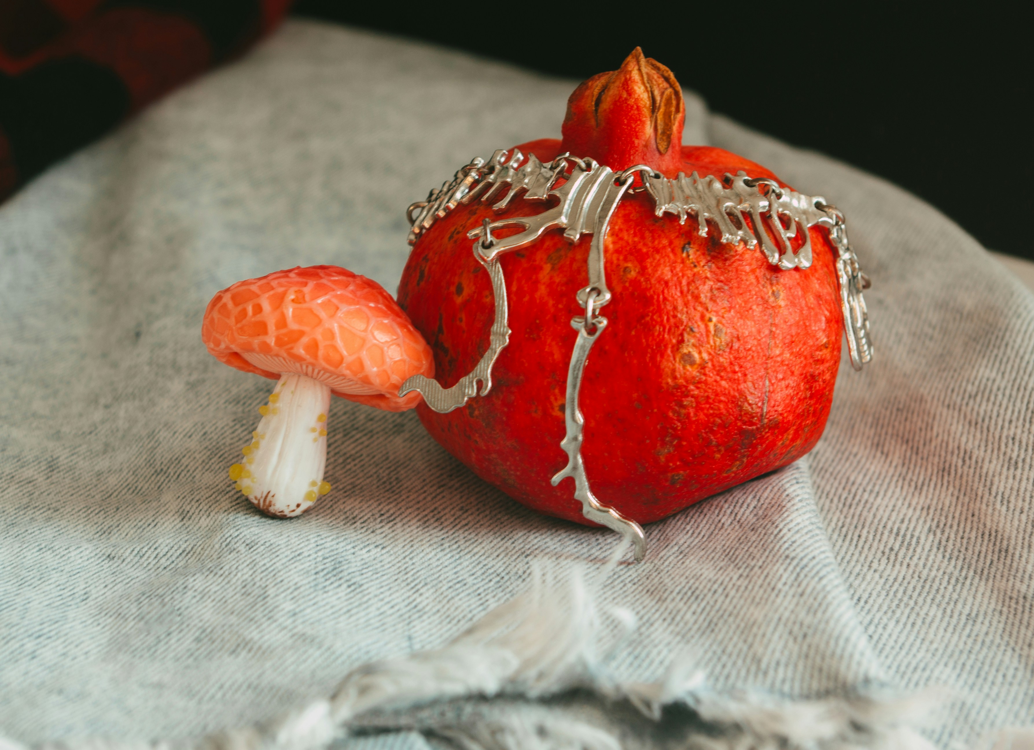 Chain-Laced Pomegranate on Soft Wool