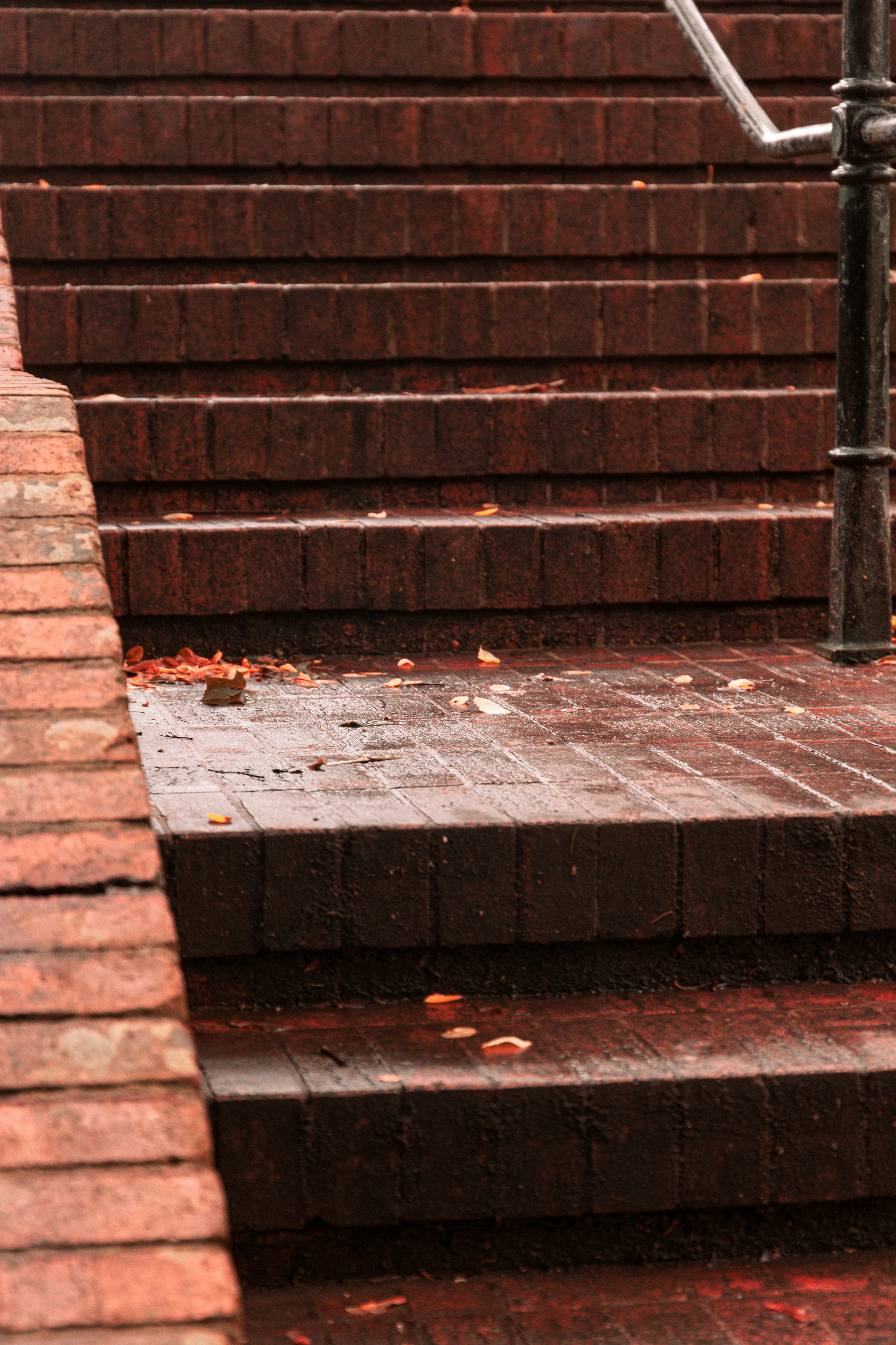 A red fire hydrant sitting on top of a set of steps photo – Free Brick ...