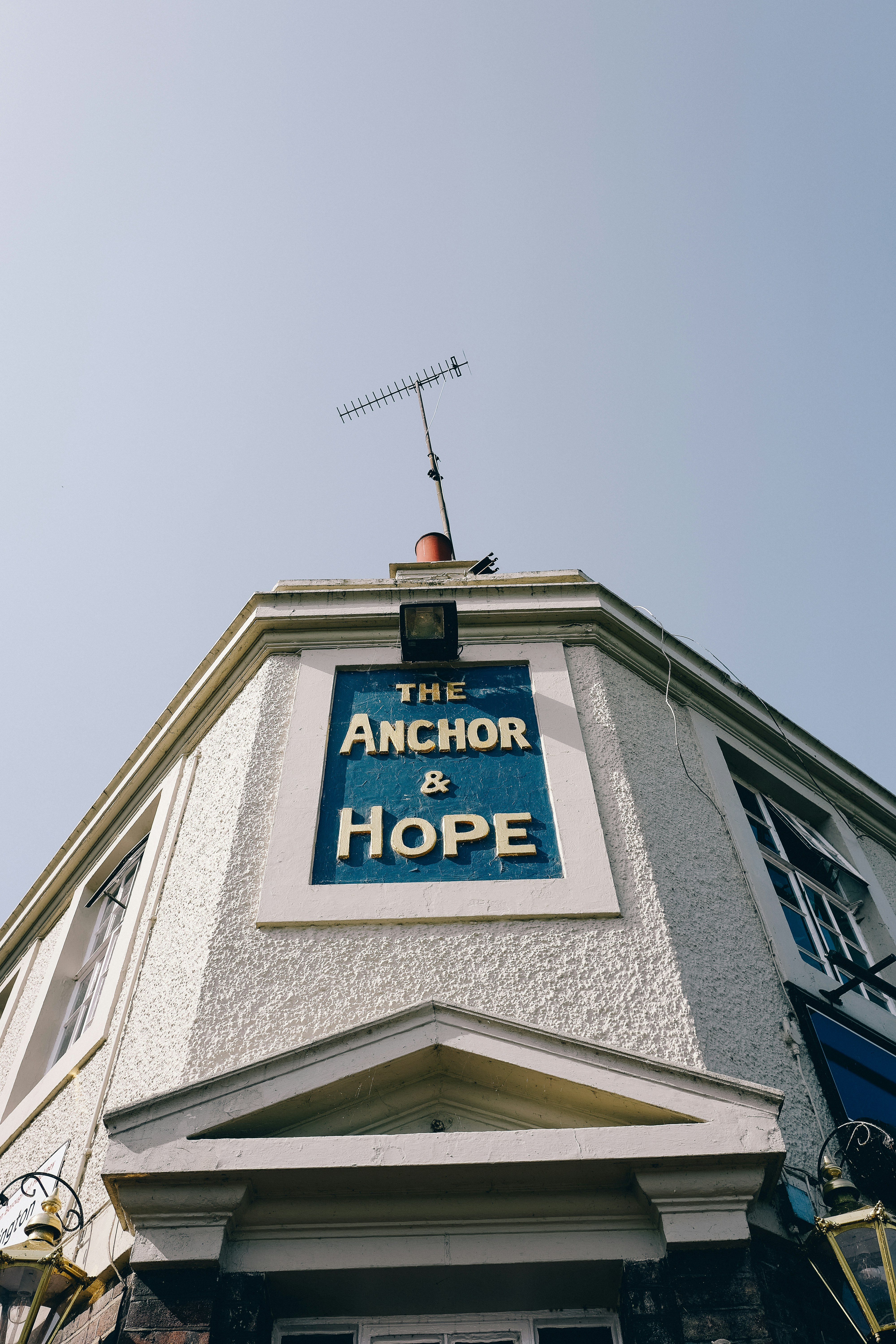 The anchor and hope sign on the side of a building photo – Free Anchor ...
