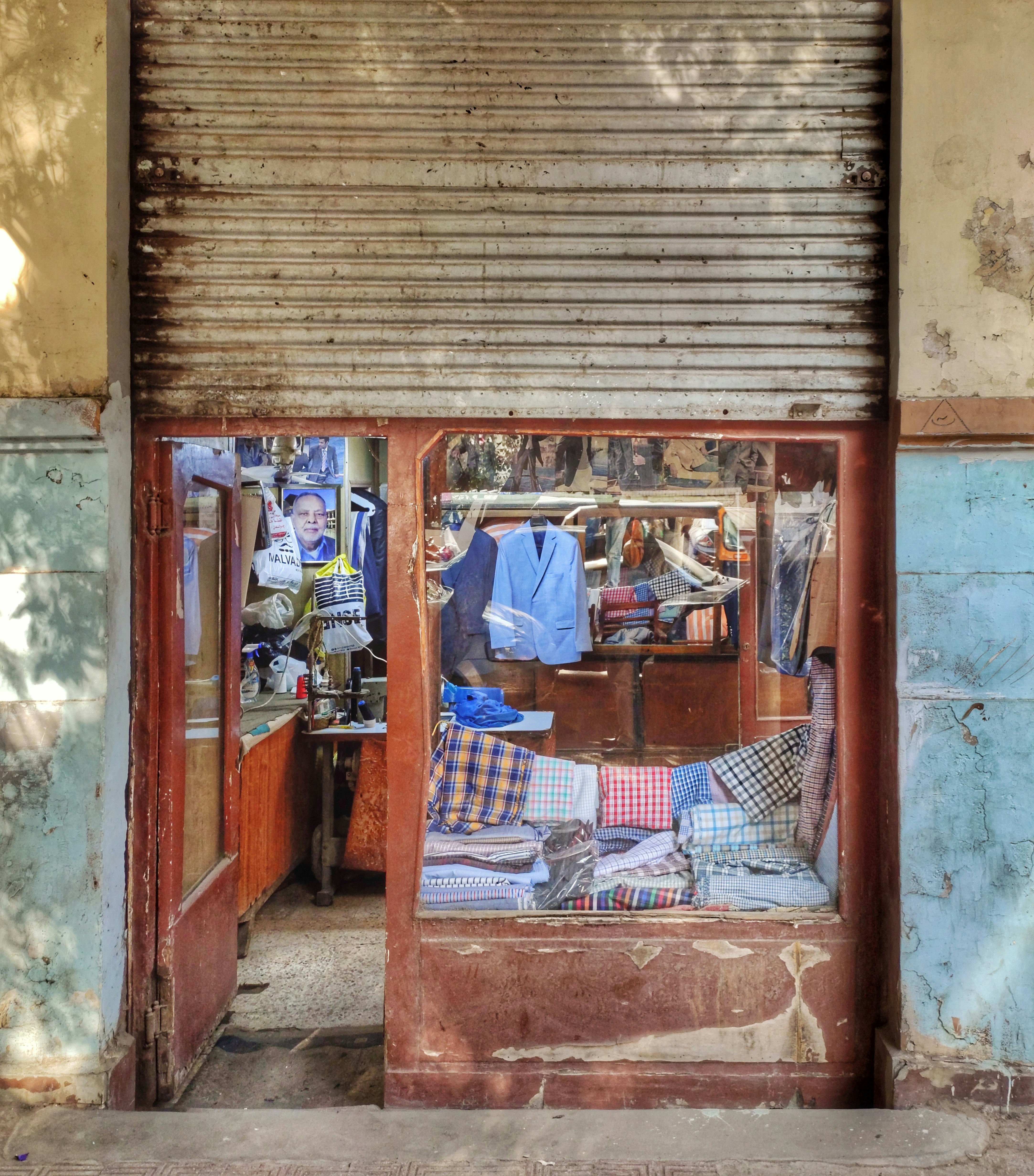 An open door to a store with clothes on display photo – Free Dailylife ...