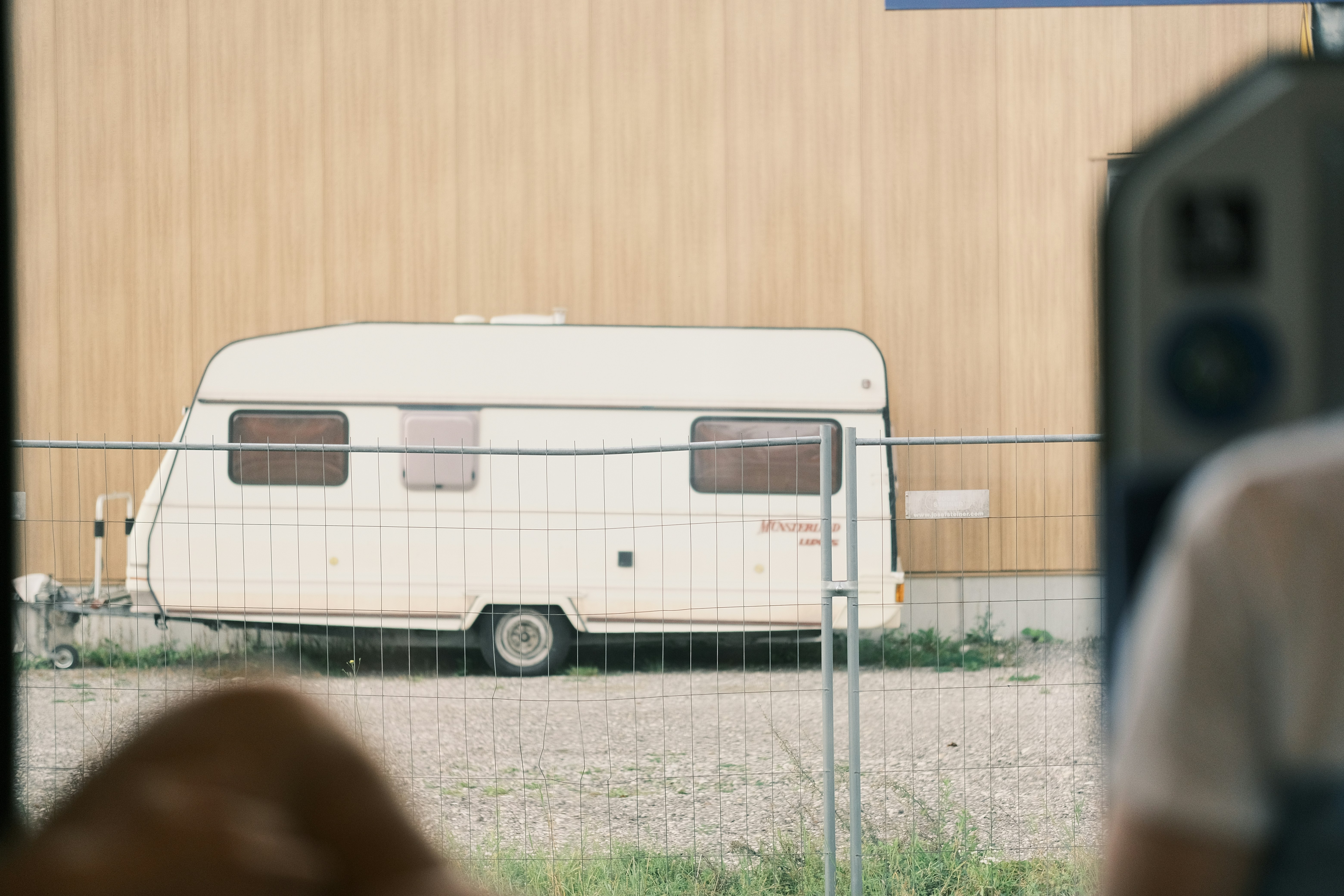 a person standing in front of a white trailer