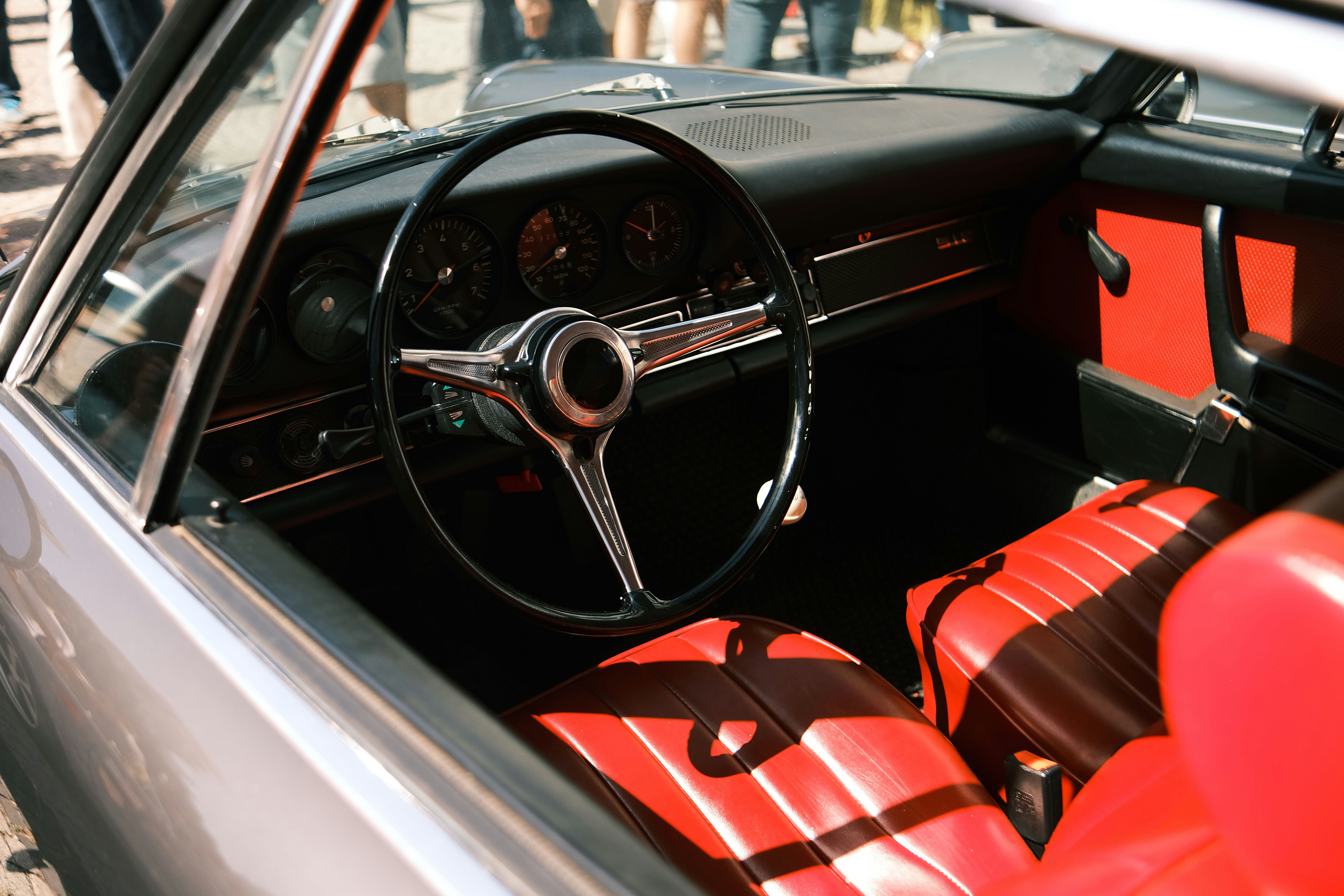Chrome Ring, Crimson Leather: A Quiet Vintage Car’s Interior