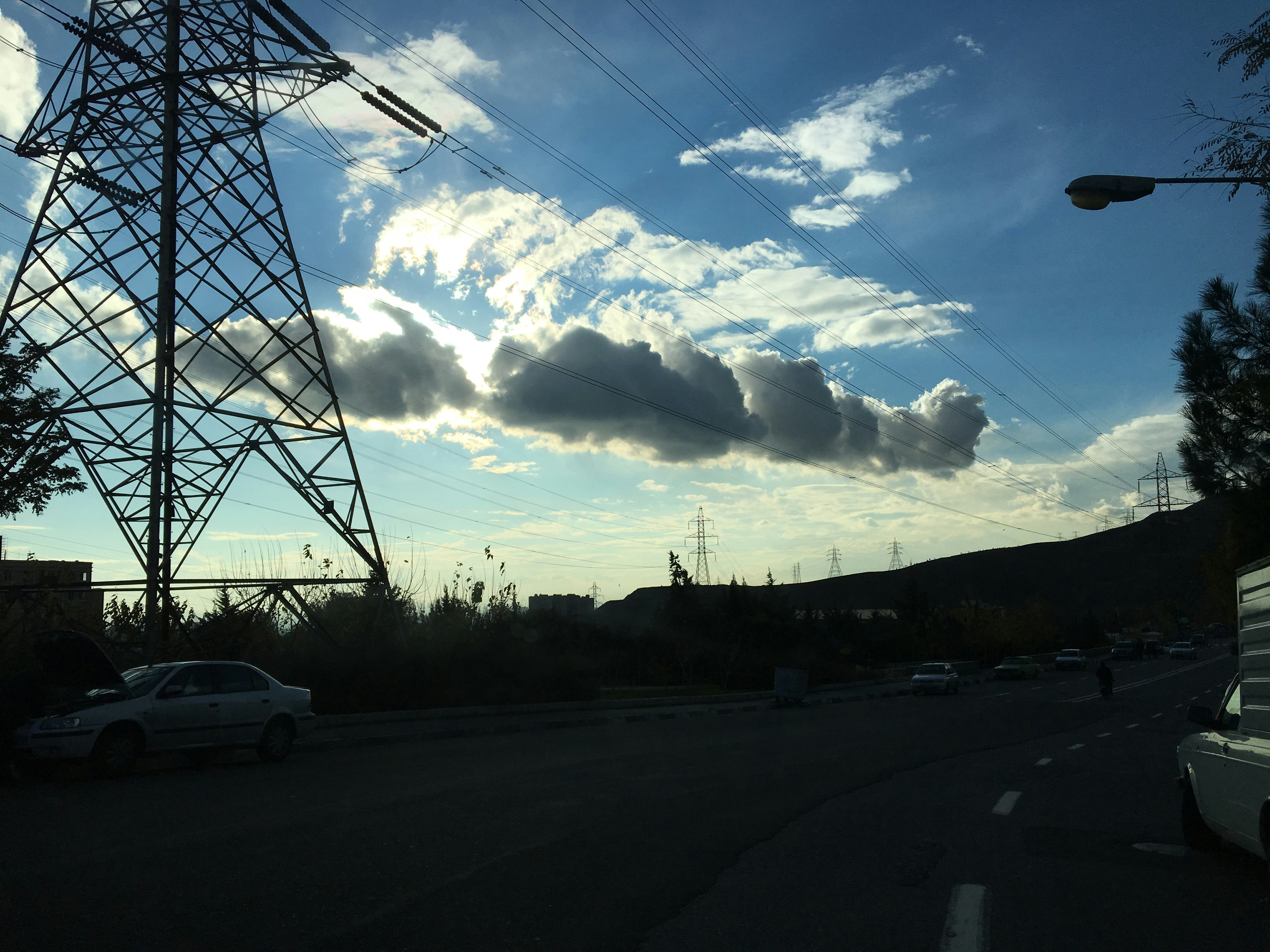 Lattice Sky: Power Tower Framing the Quiet Highway