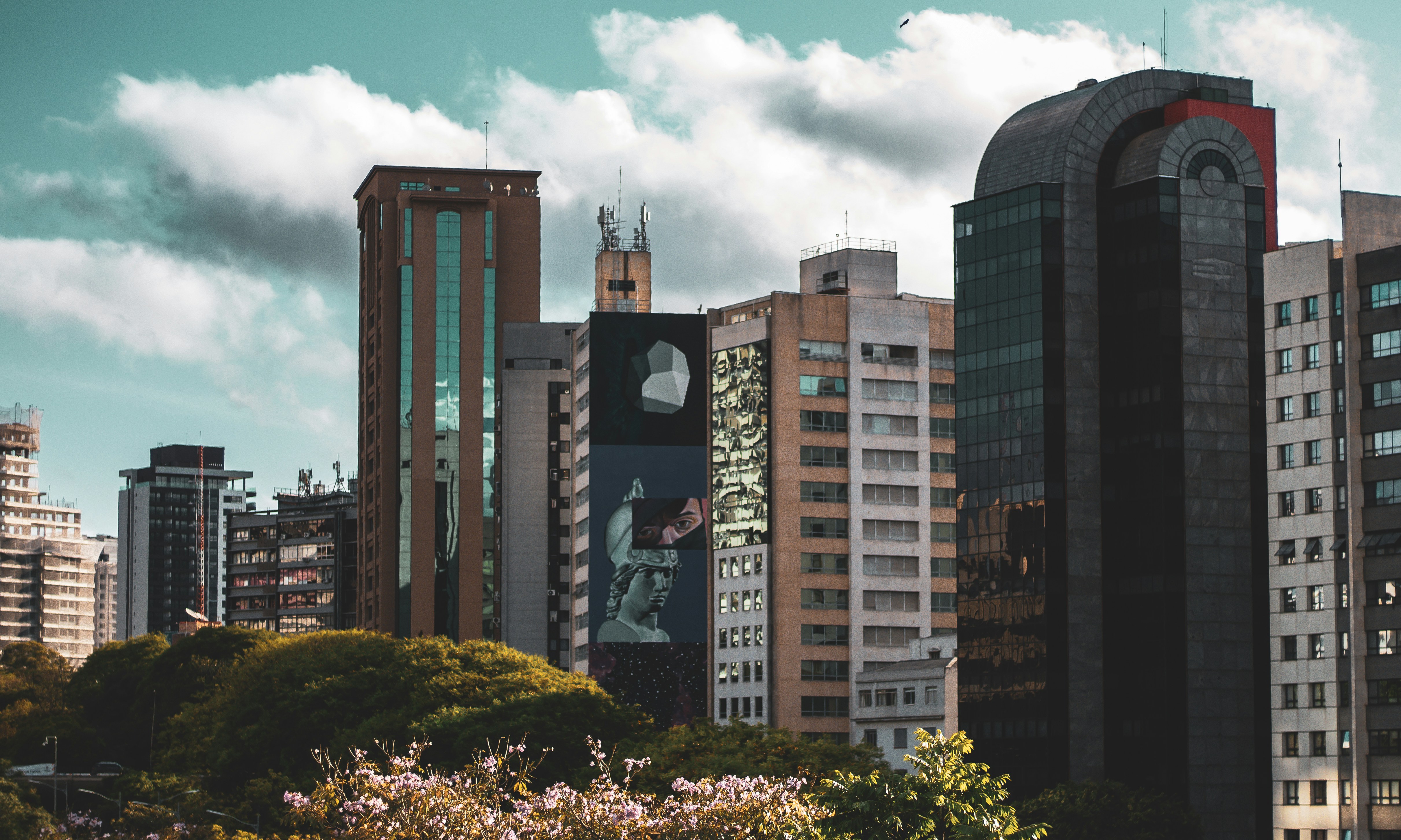 A city skyline with tall buildings and a clock tower photo – Free City ...