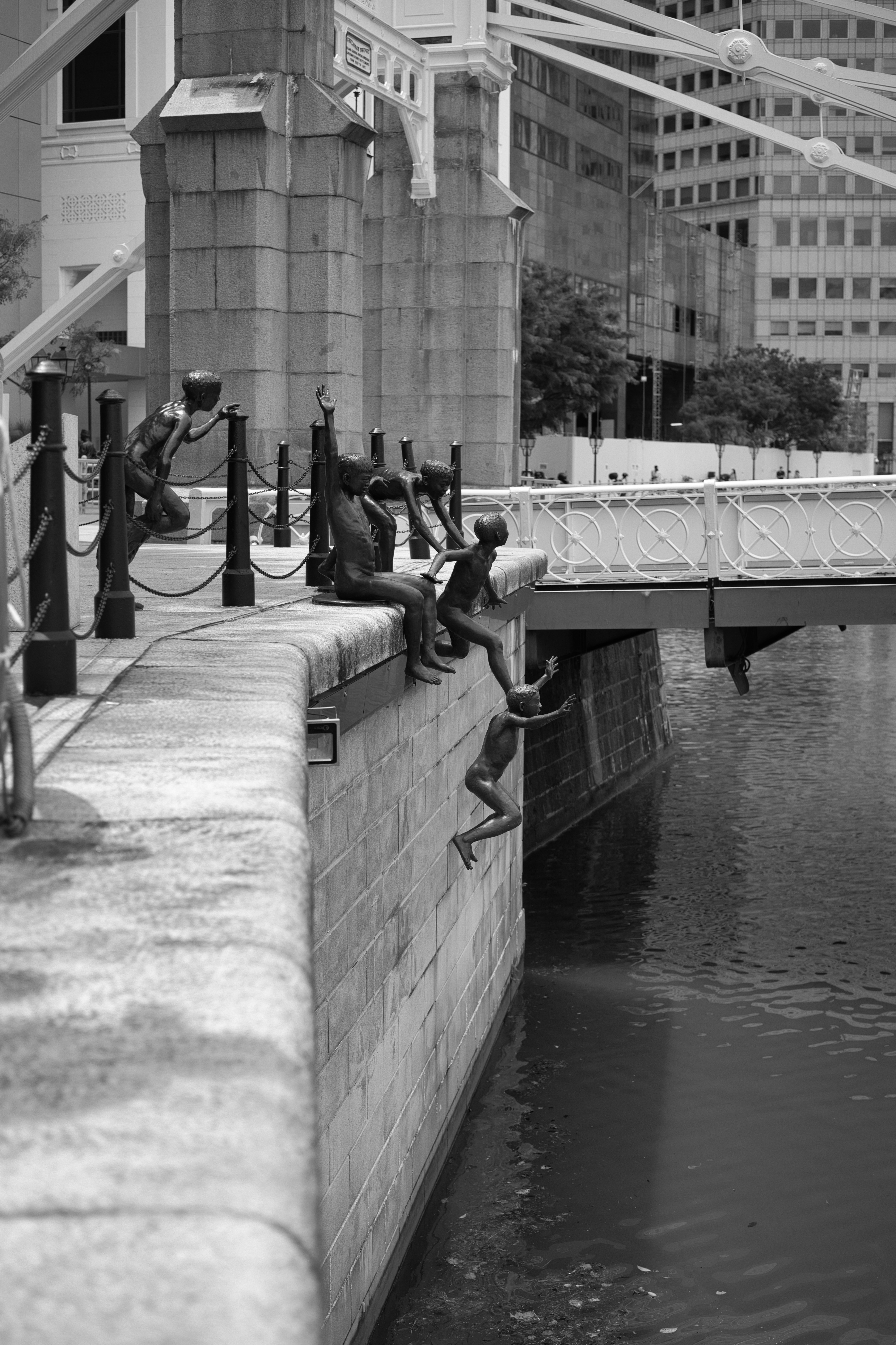 A person jumping off a ledge into a body of water photo – Free ...