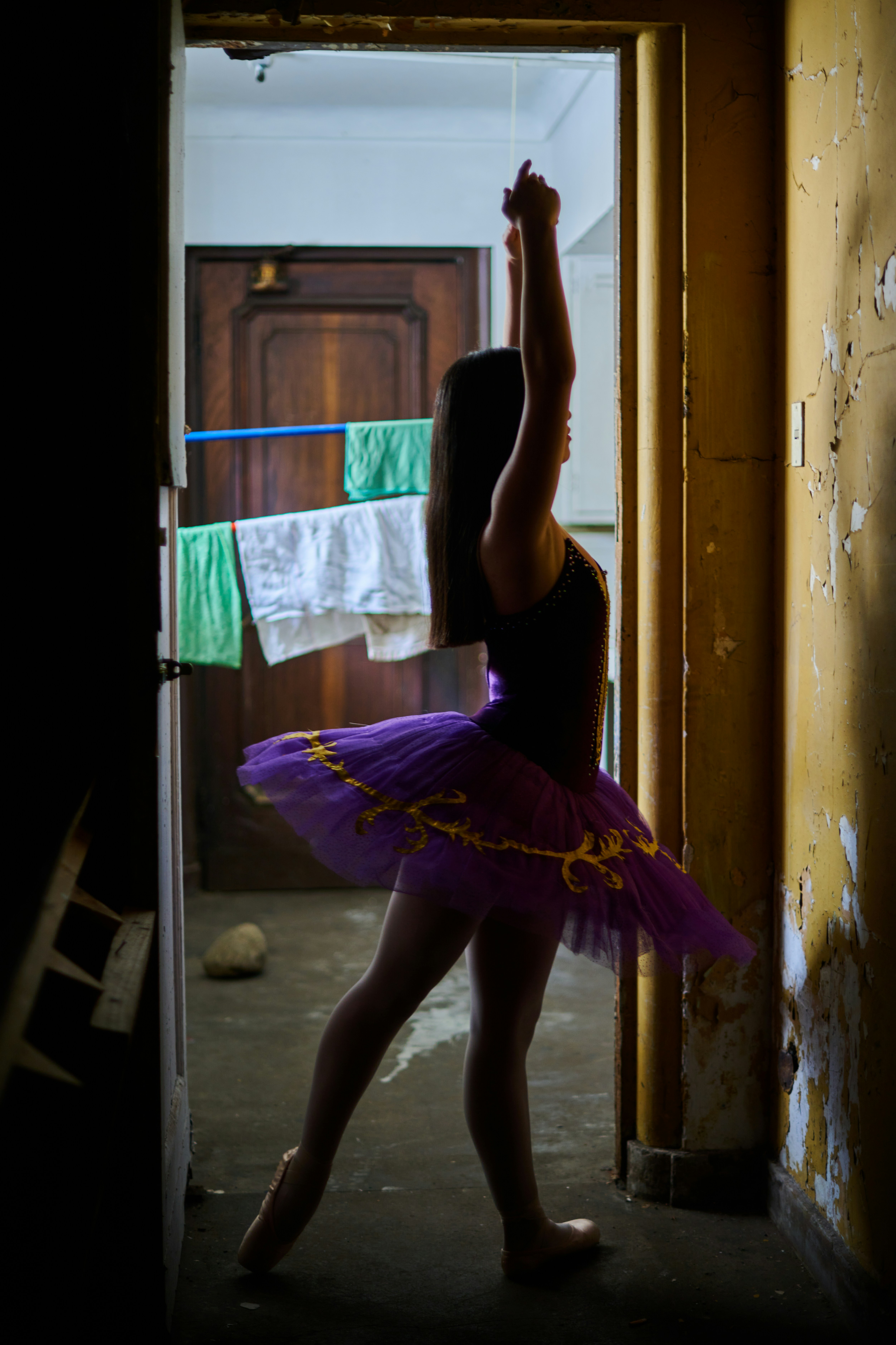 Doorway Ballerina: A Quiet Spin Beneath Laundry Lines