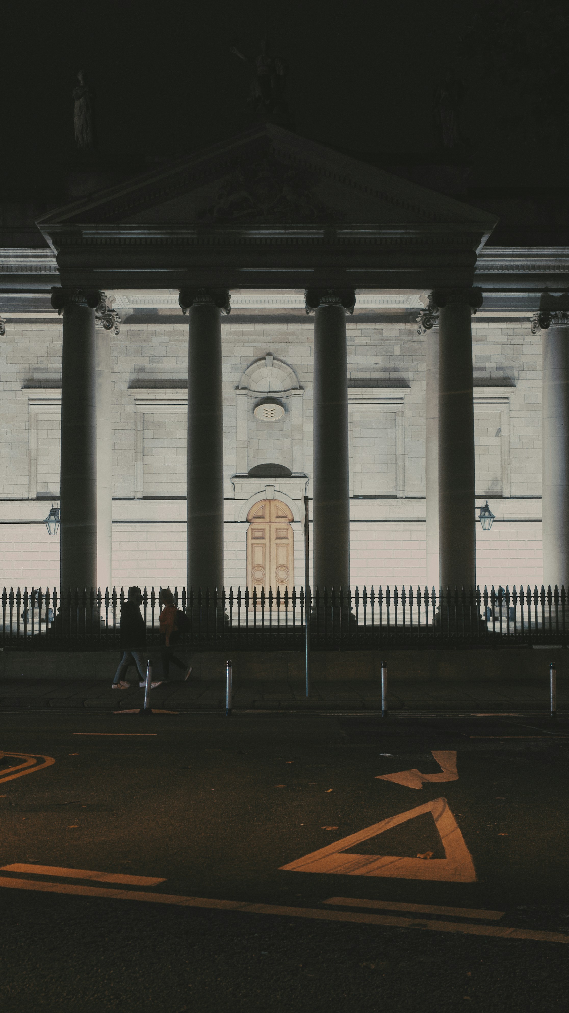 A couple of people that are standing in front of a building photo ...