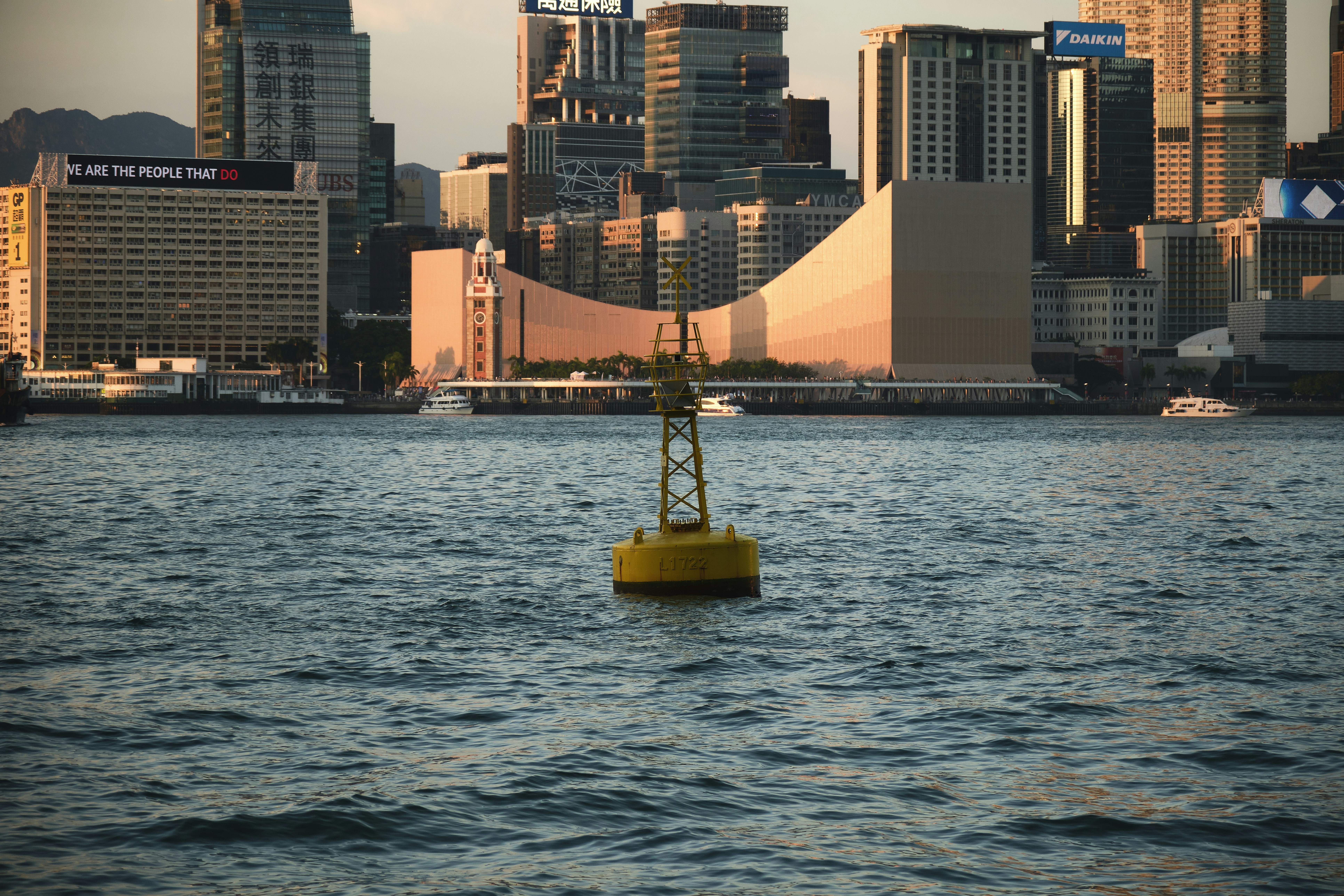 A yellow buoy floating in the middle of a body of water photo – Free ...