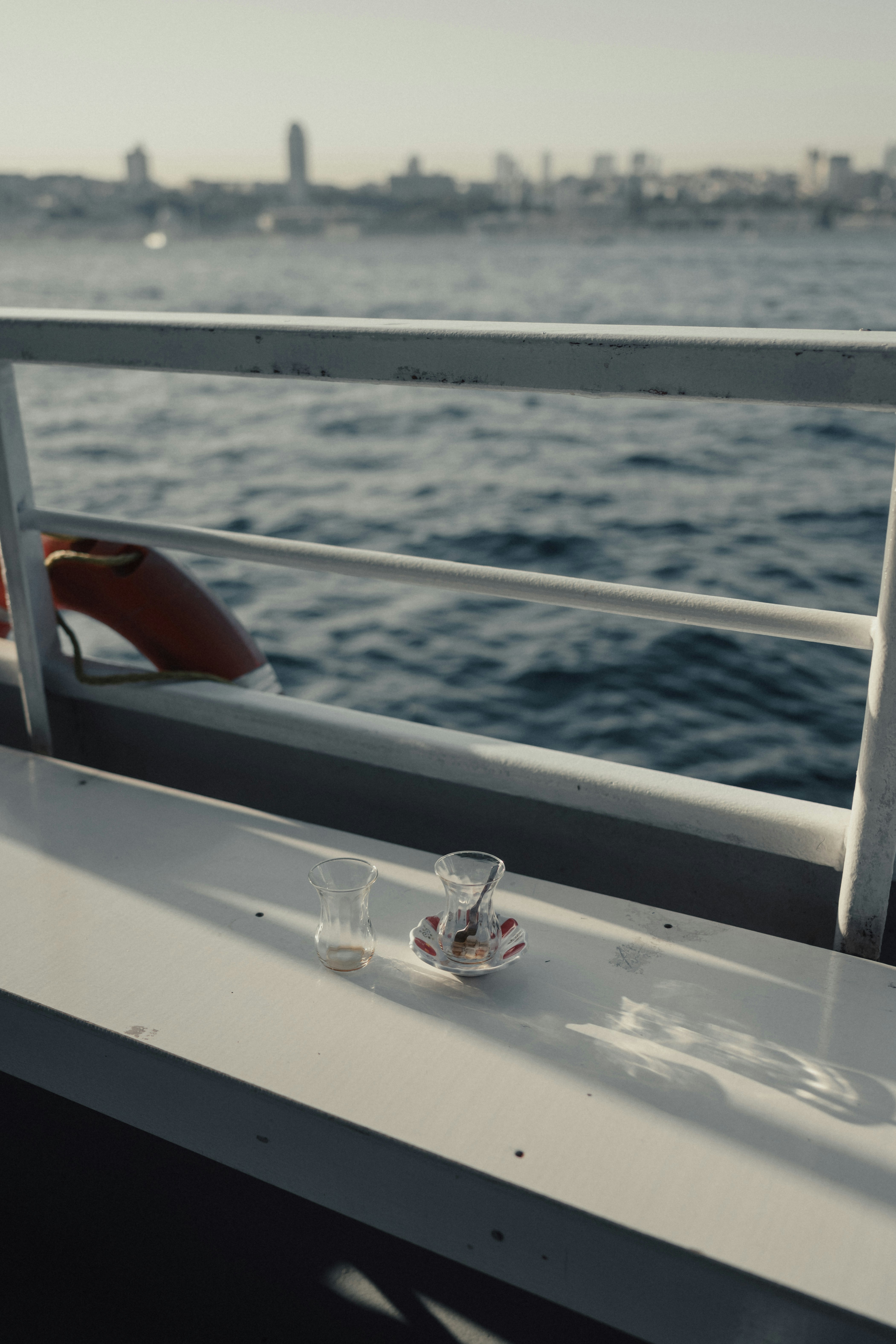 Glass Vignette on a Ferry Deck with a Distant City Skyline