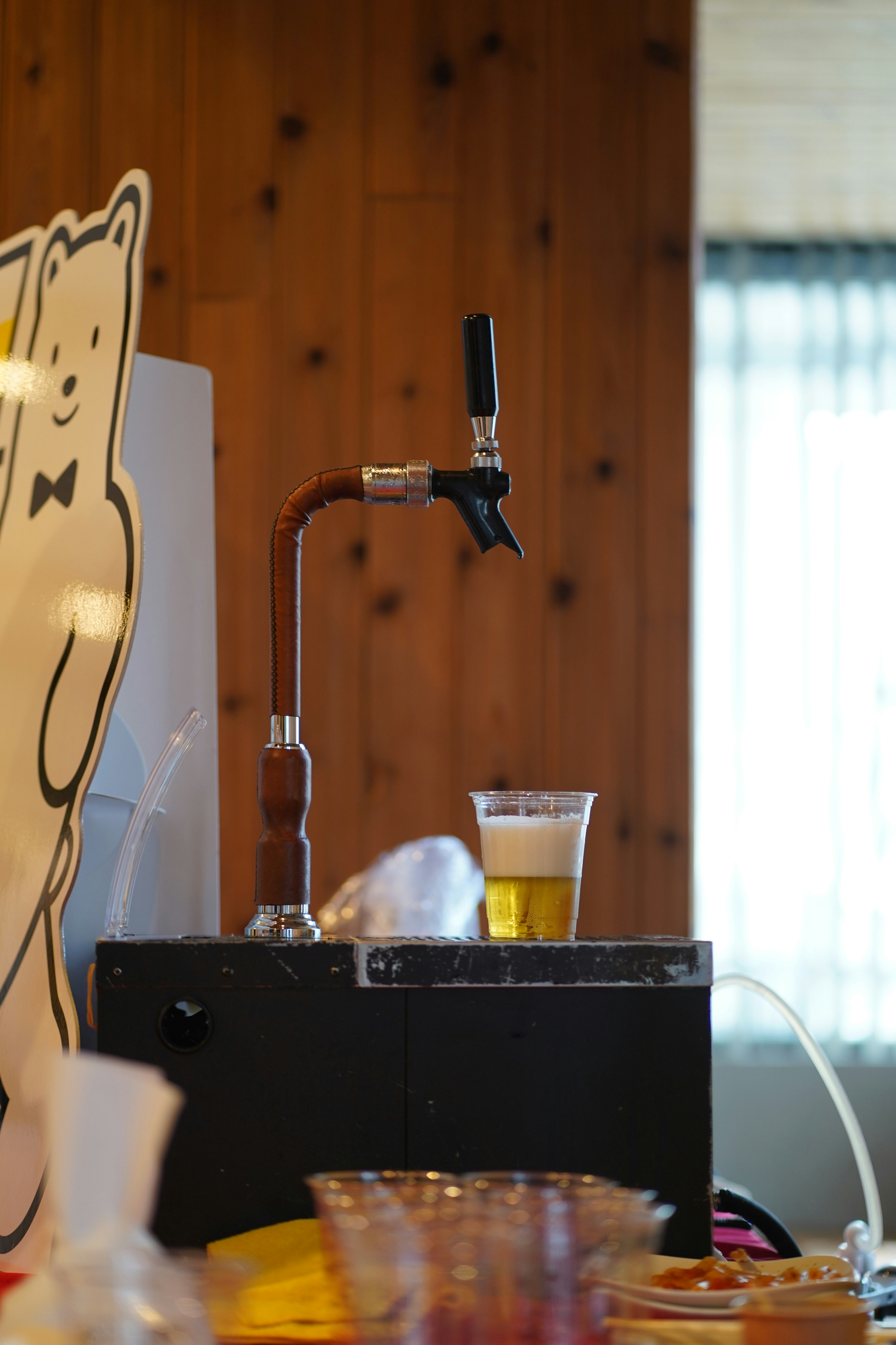 Foam on Tap: Copper Pipe Beer Tap Framed by Warm Wood and a Playful Mascot