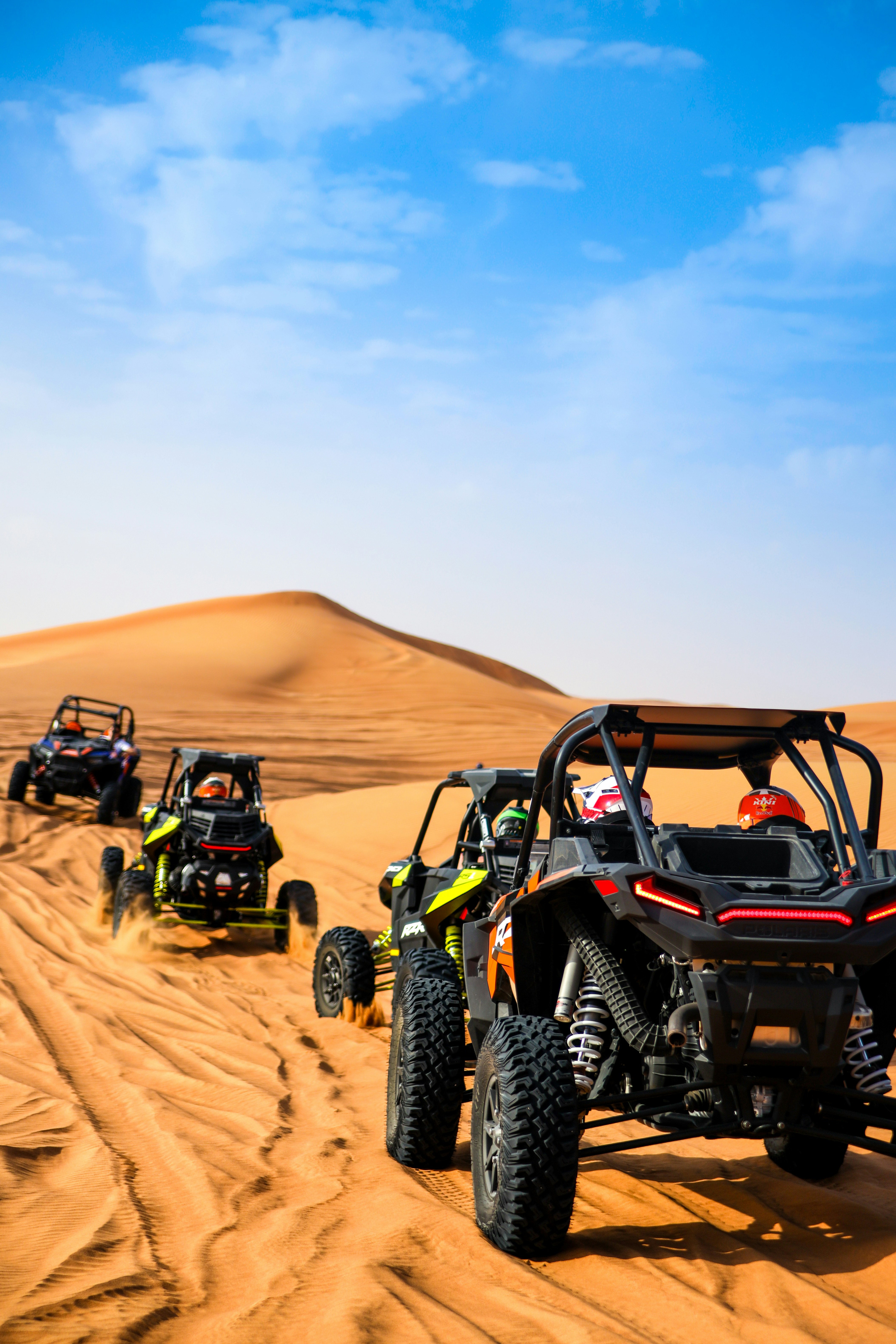 A group of four buggies driving through the desert photo – Free Desert ...