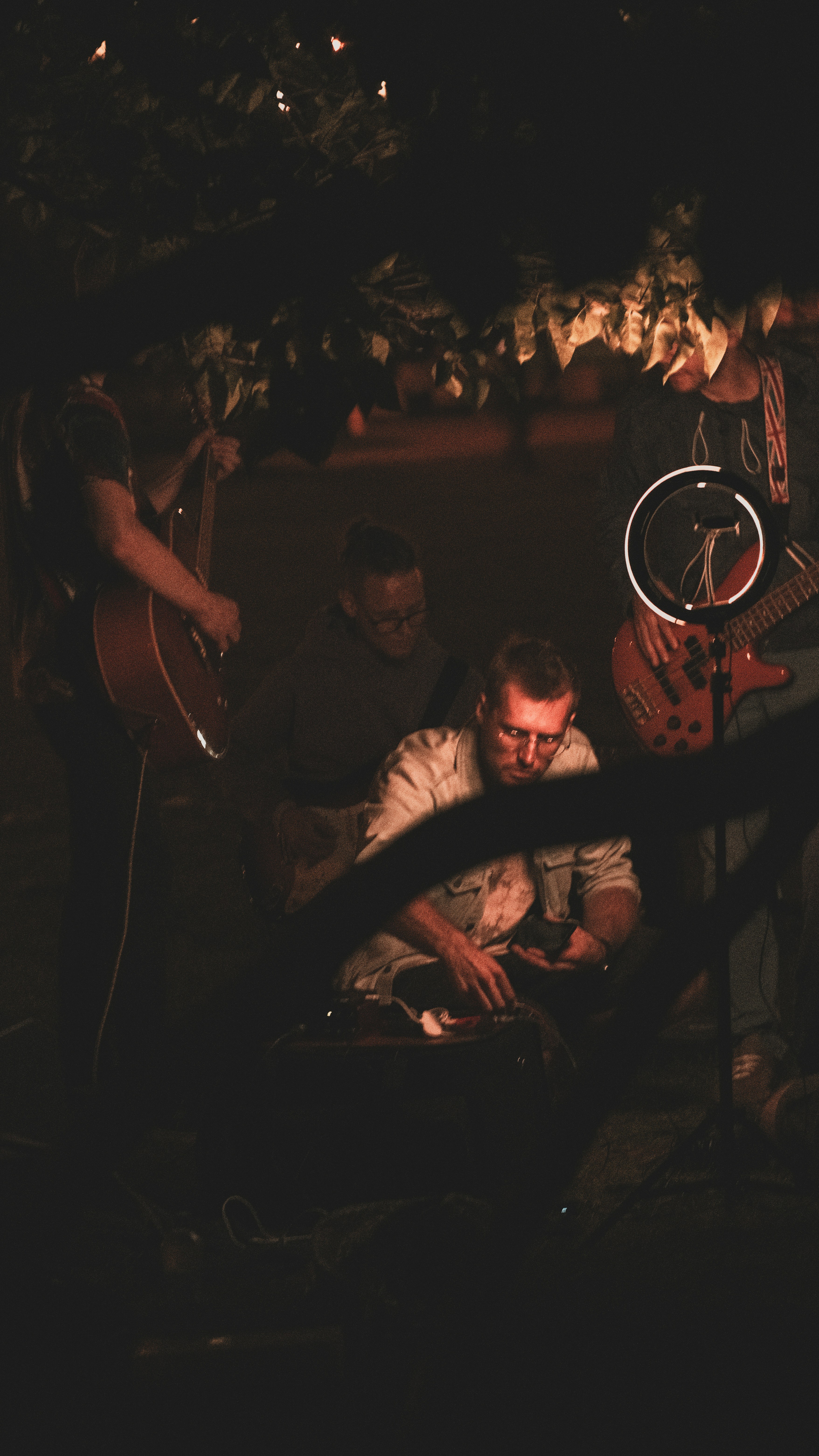 Midnight Jam: A guitarist and friends circle around a seated drummer