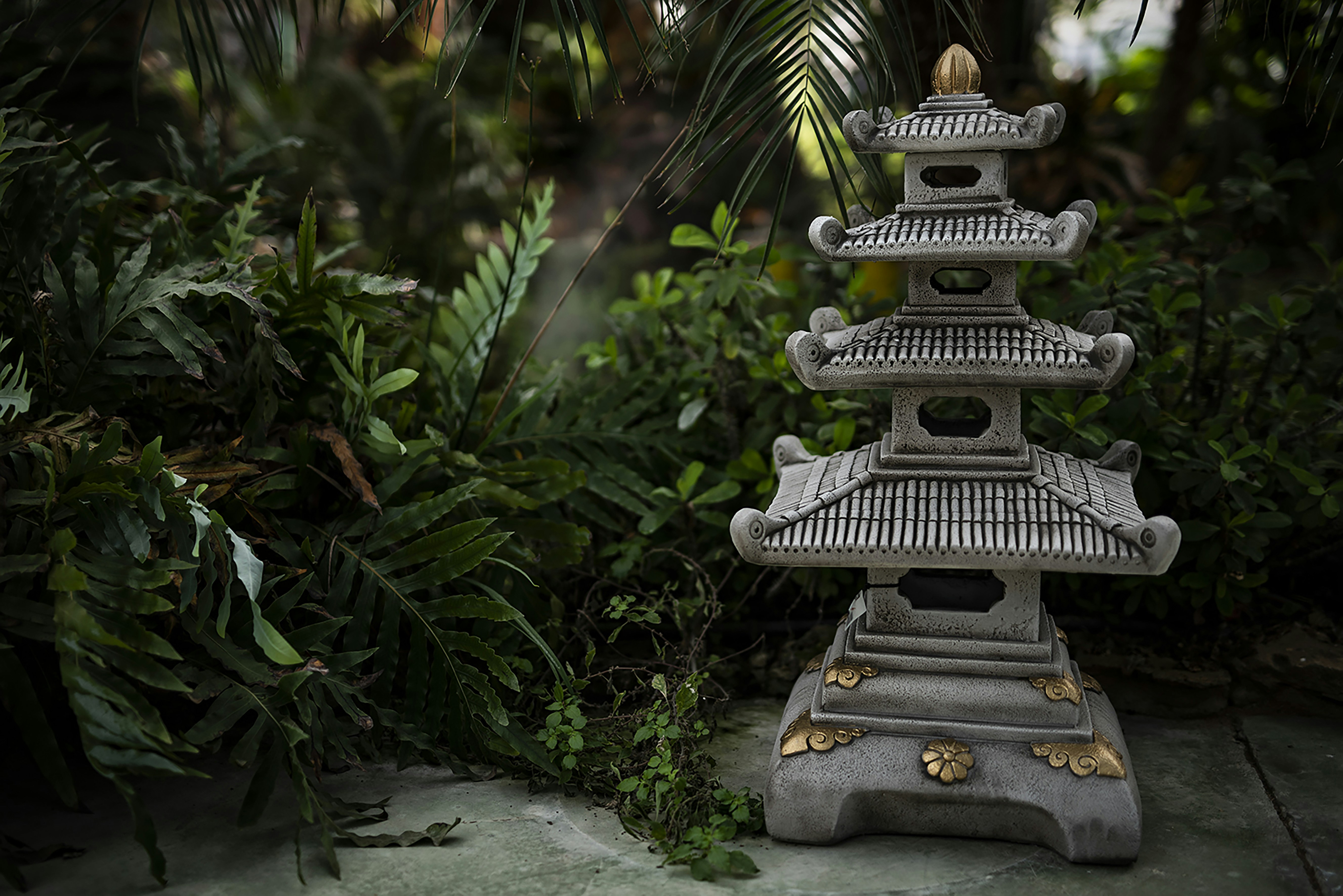Stone Pagoda Lantern Framed by Lush Greenery in a Quiet Garden