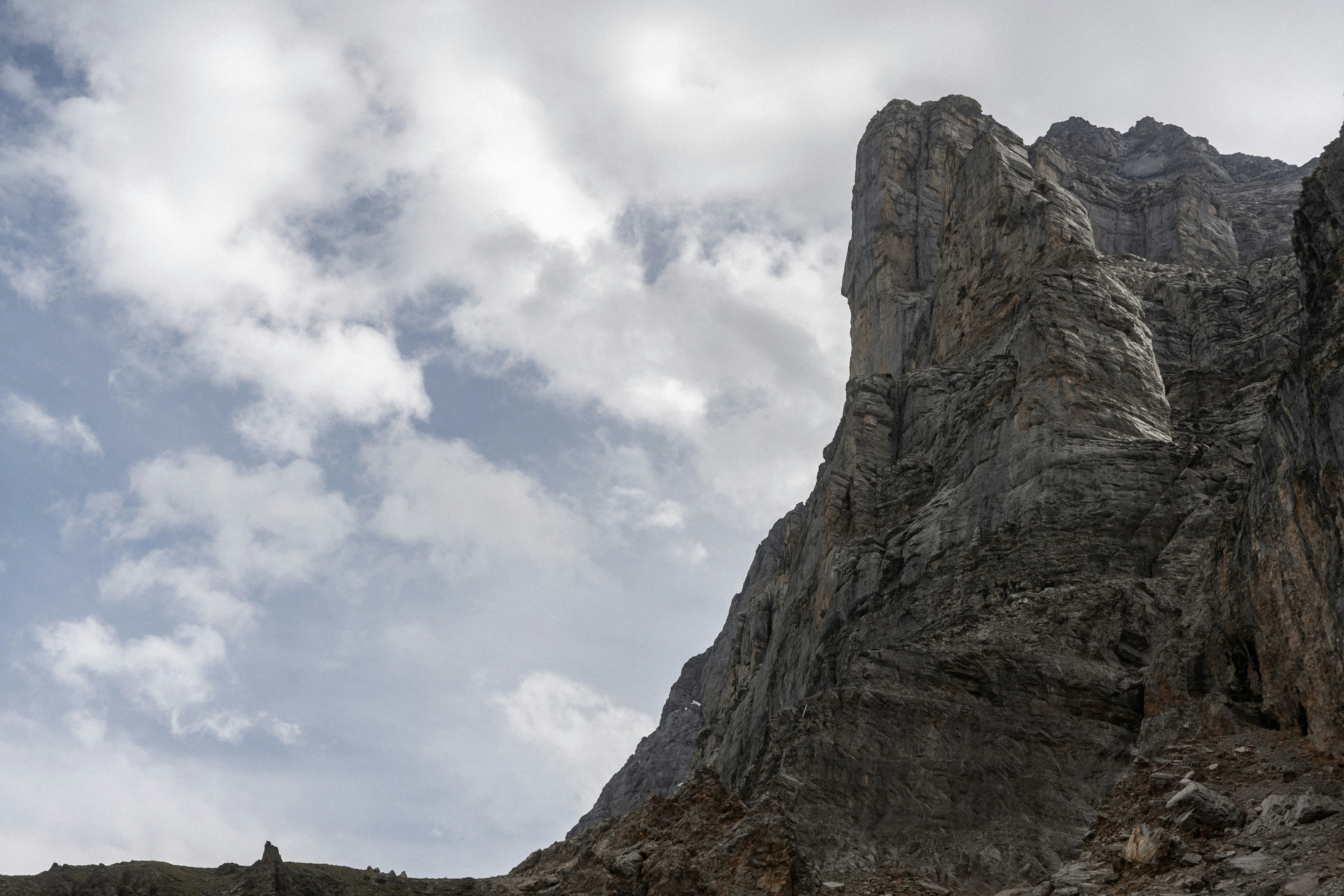 A very tall mountain with a sky background photo – Free Cliff Image on ...