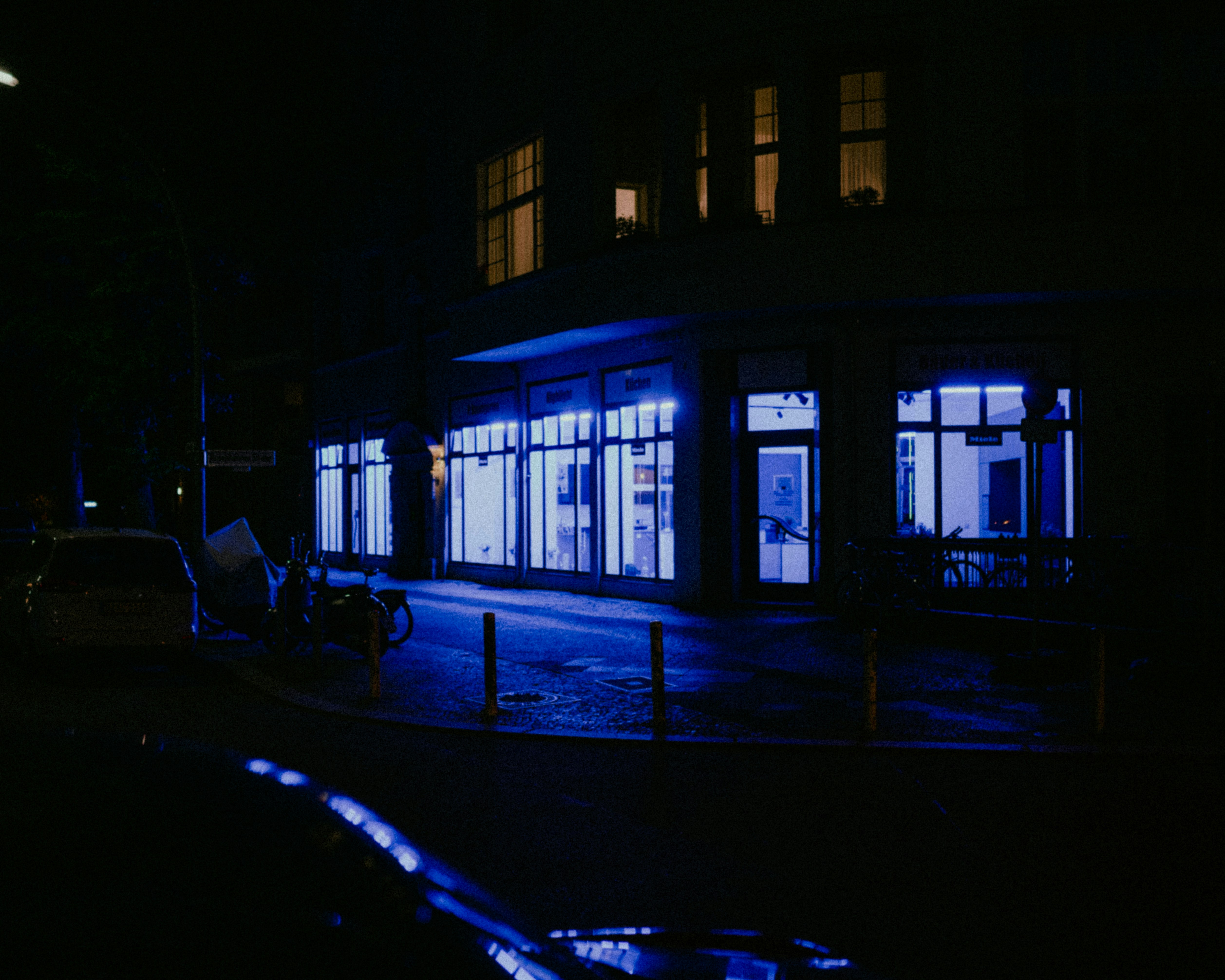 Blue Neon Quiet: Midnight storefronts under electric glow