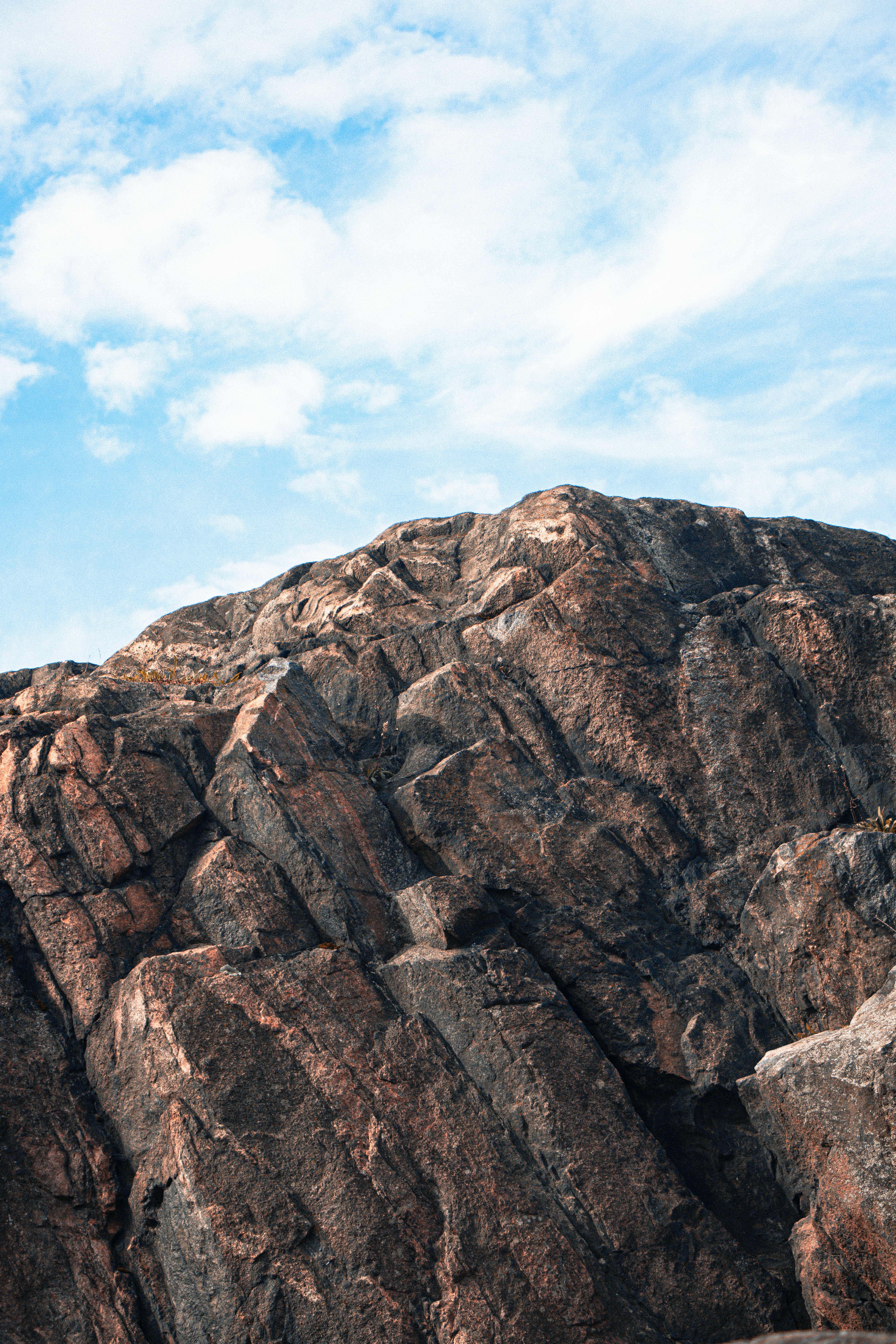 a large rock formation with a blue sky in the background