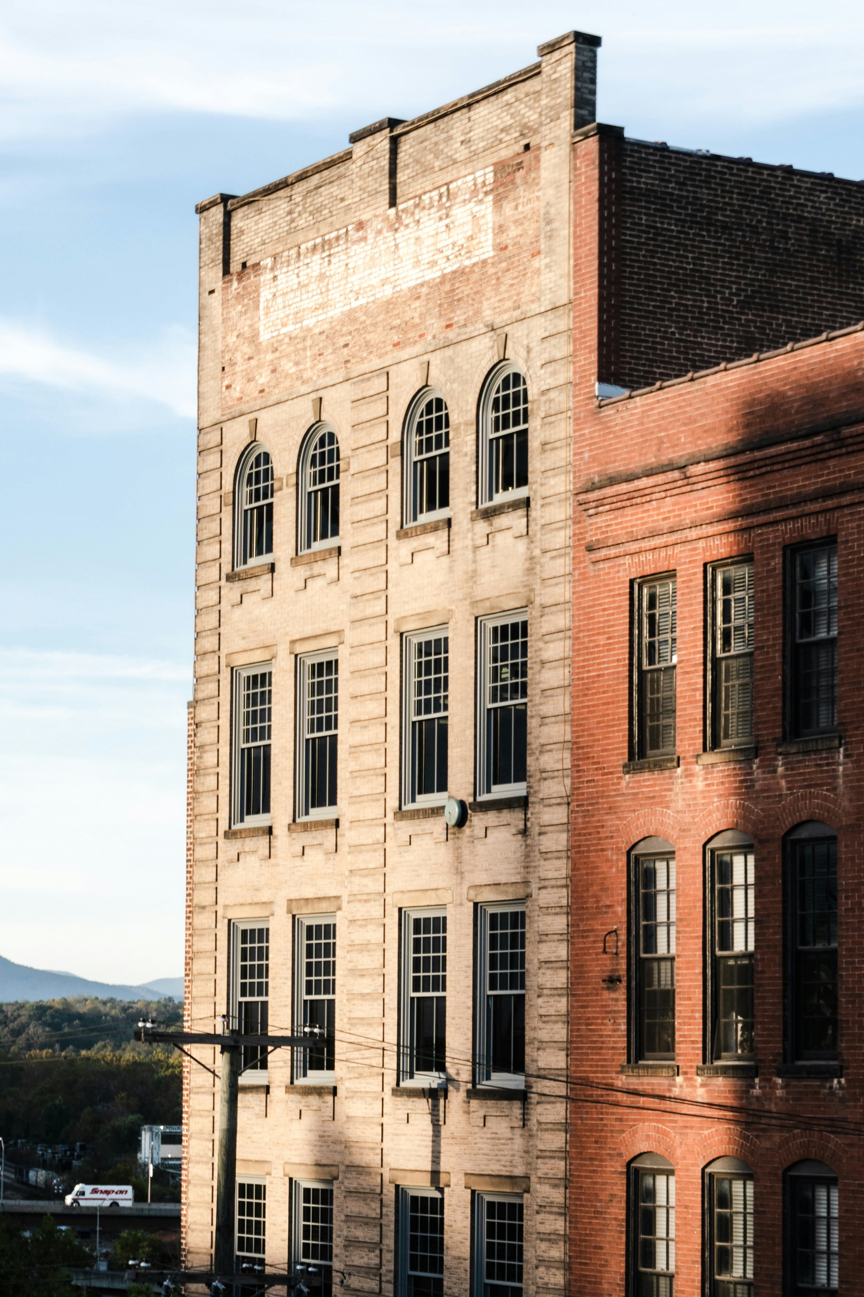 Sunlit Brick Facade: An Elevation of Arched Windows