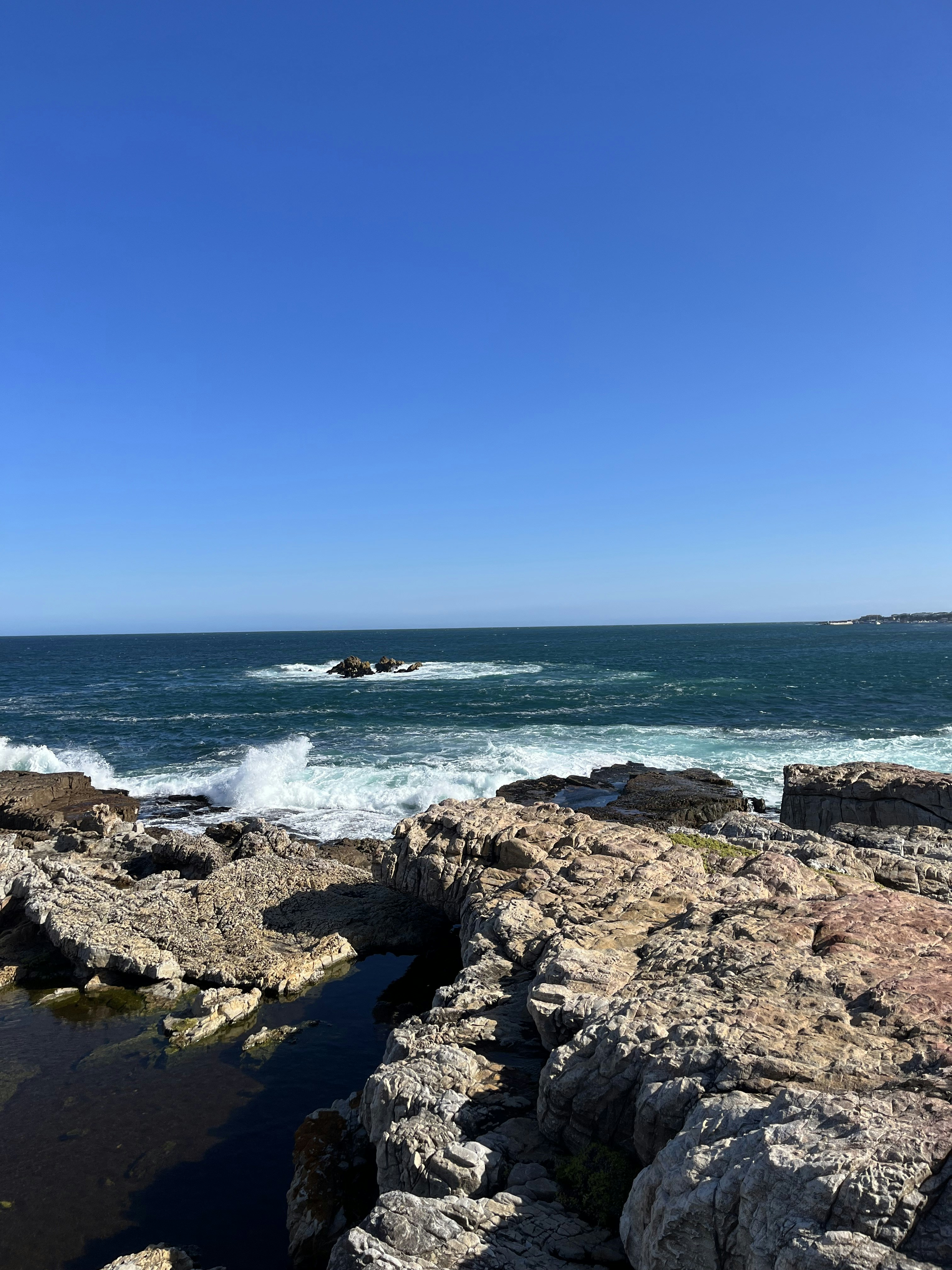 A view of the ocean from a rocky shore photo – Free Wallpaper Image on ...