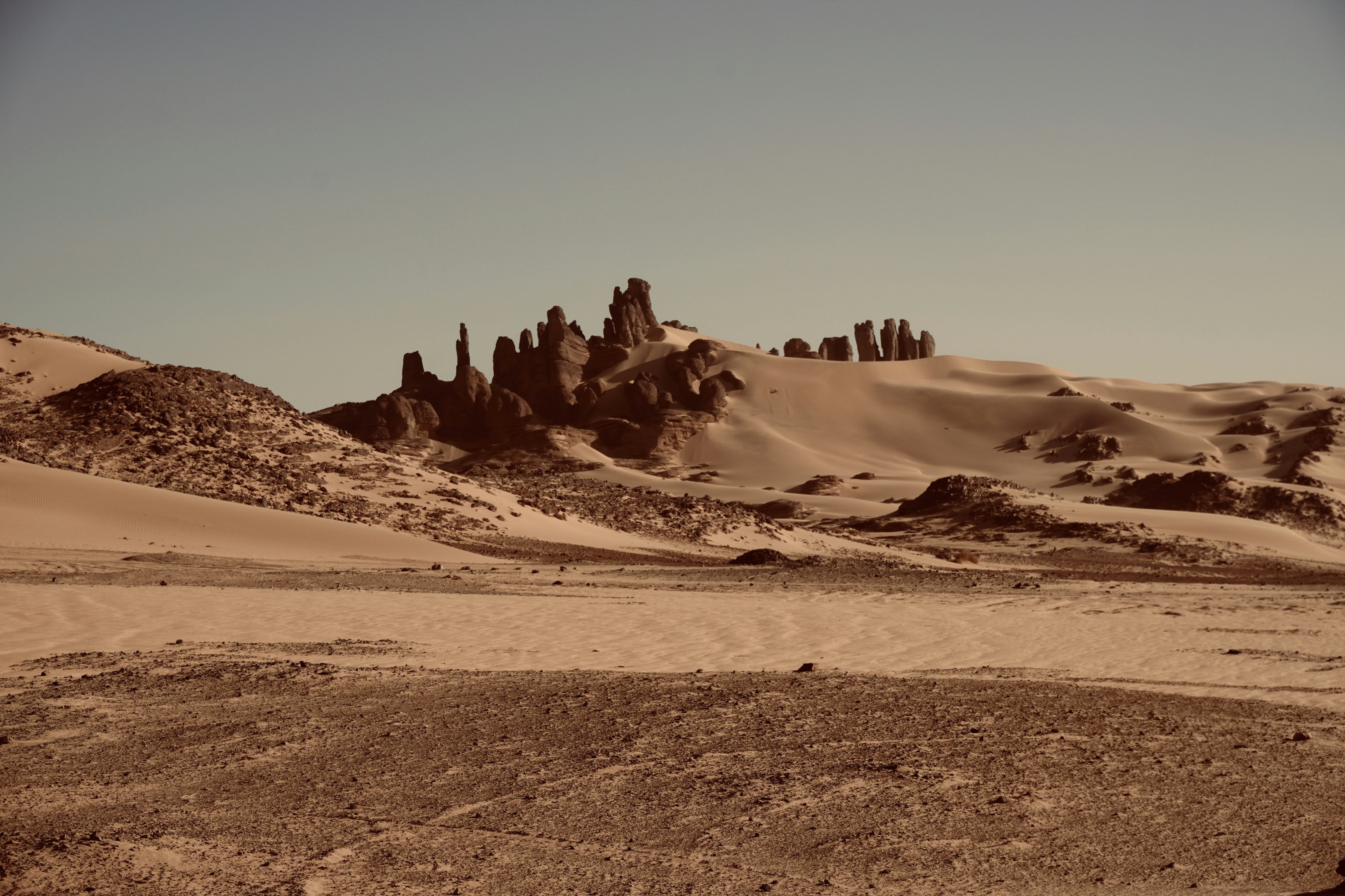Sand dunes in the cliffs of Tin Akachakar in Ahaggar National Park (Tassili du Hoggar), southern Algeria. photo made by rouichi / switzerland