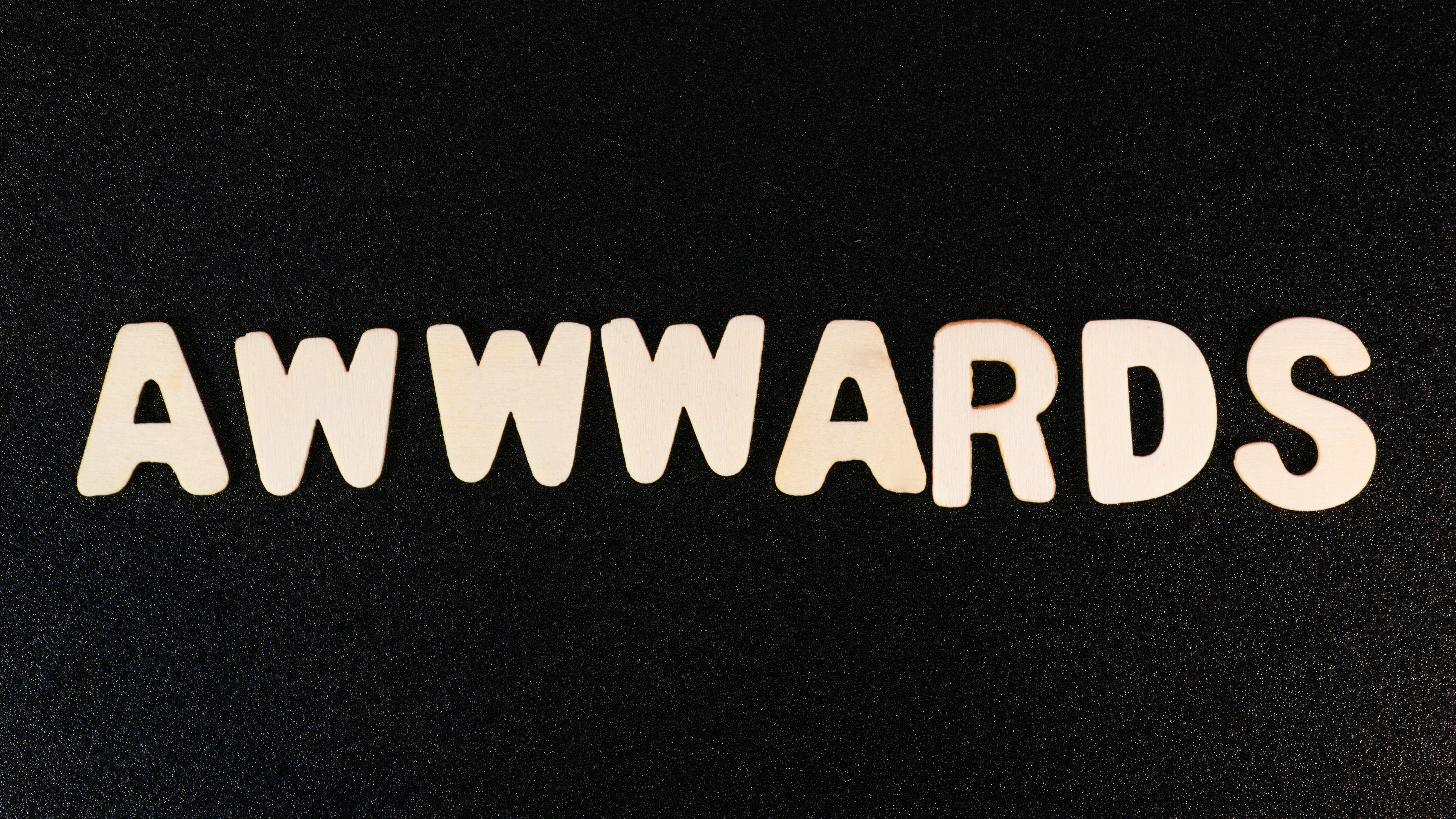 A close up of the word awwards on a black background photo – Free Awwwards Image on Unsplash