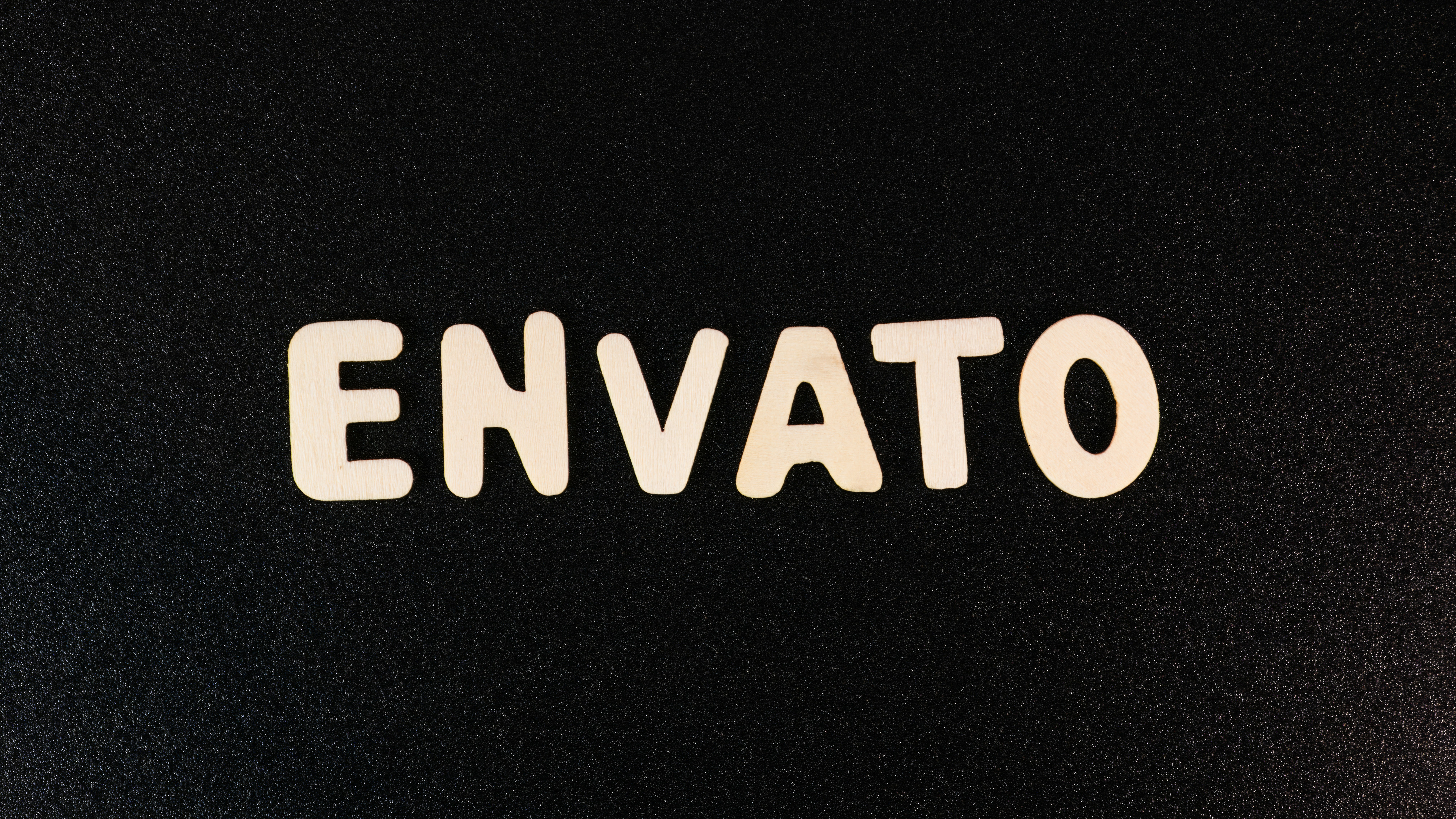 The word envato written in white on a black background photo – Free ...