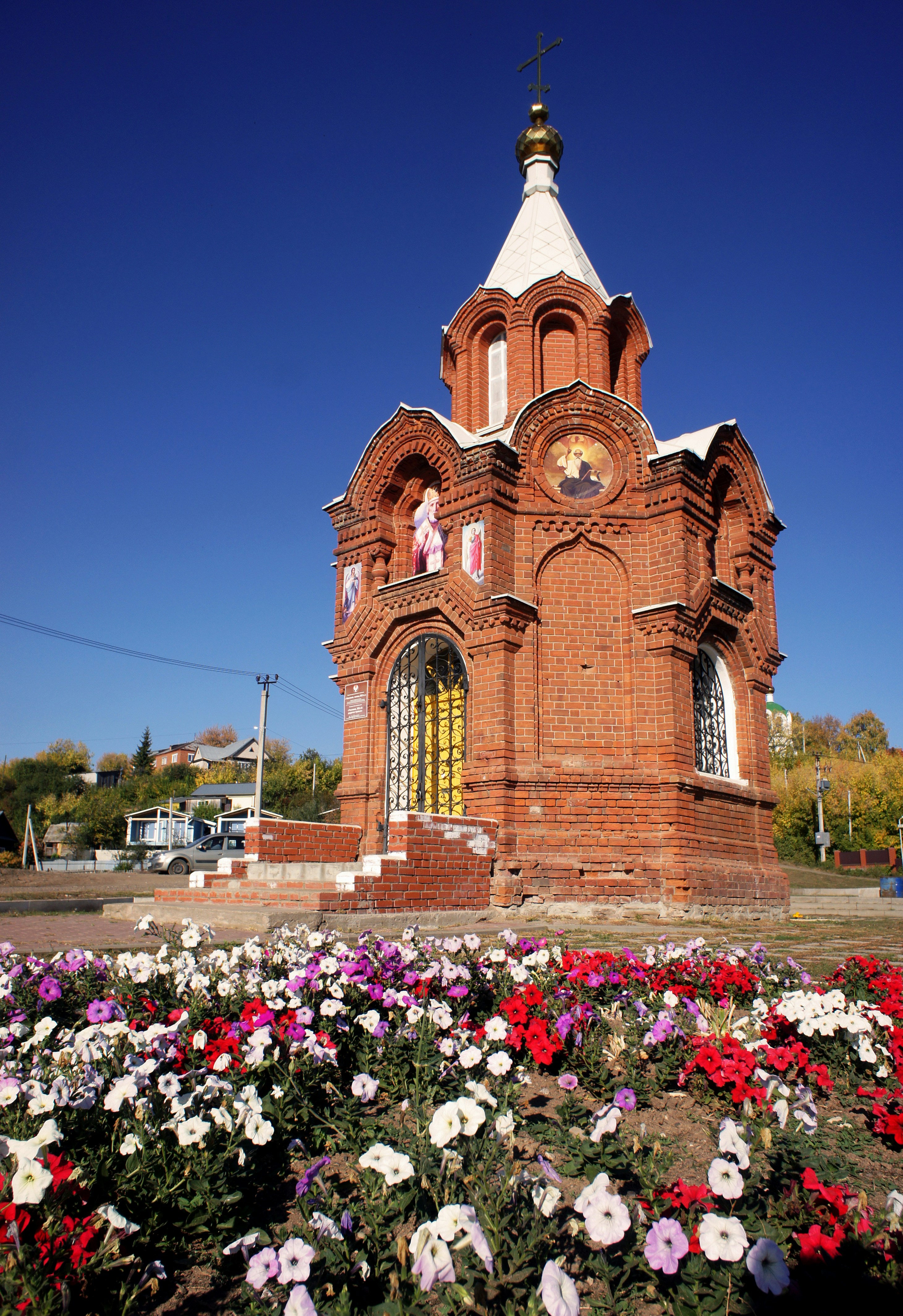 Crimson Chapel with a White Dome Framed by Spring Blooms