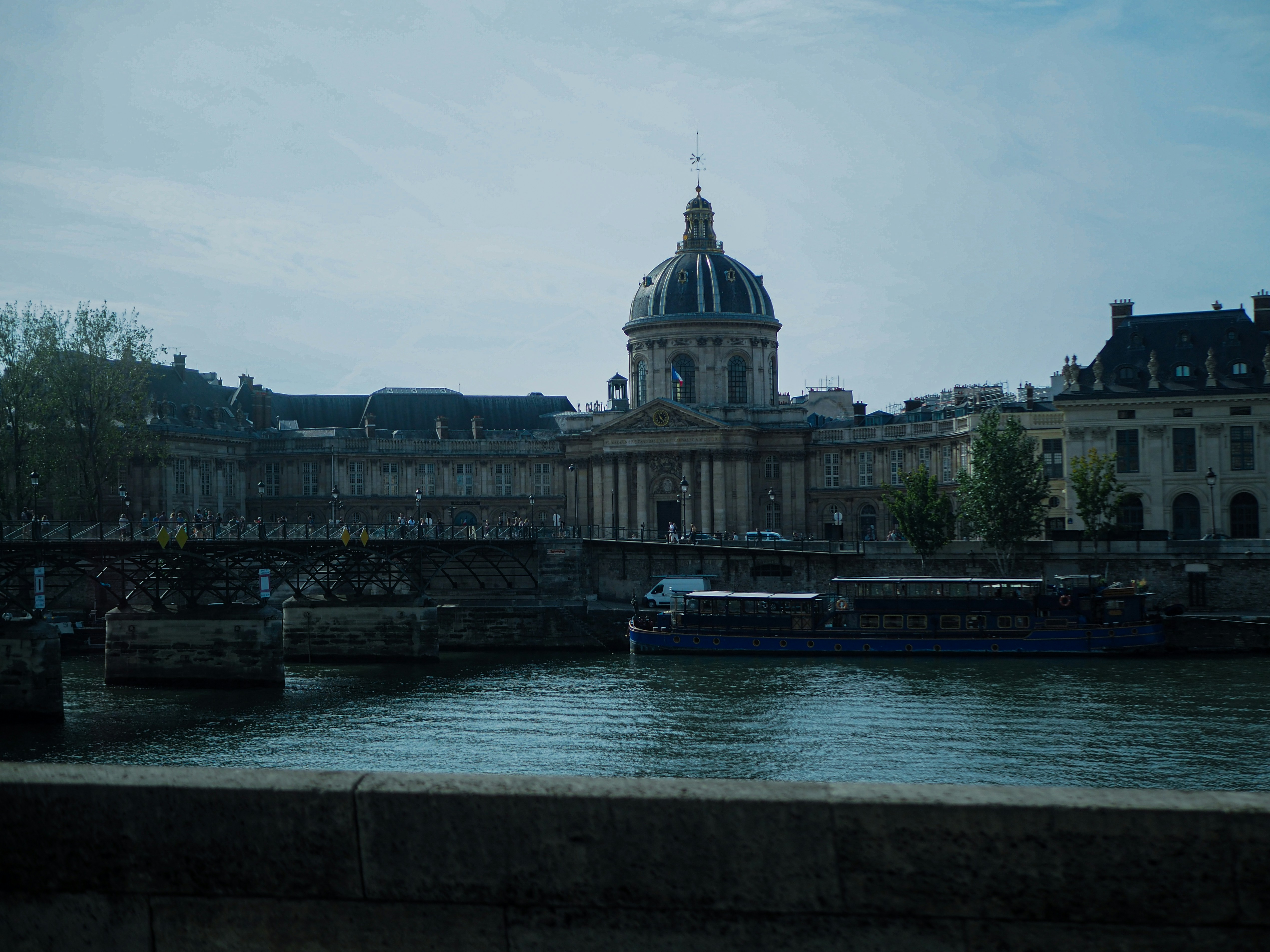 Classic dome structure viewed across a river under a clear blue sky.