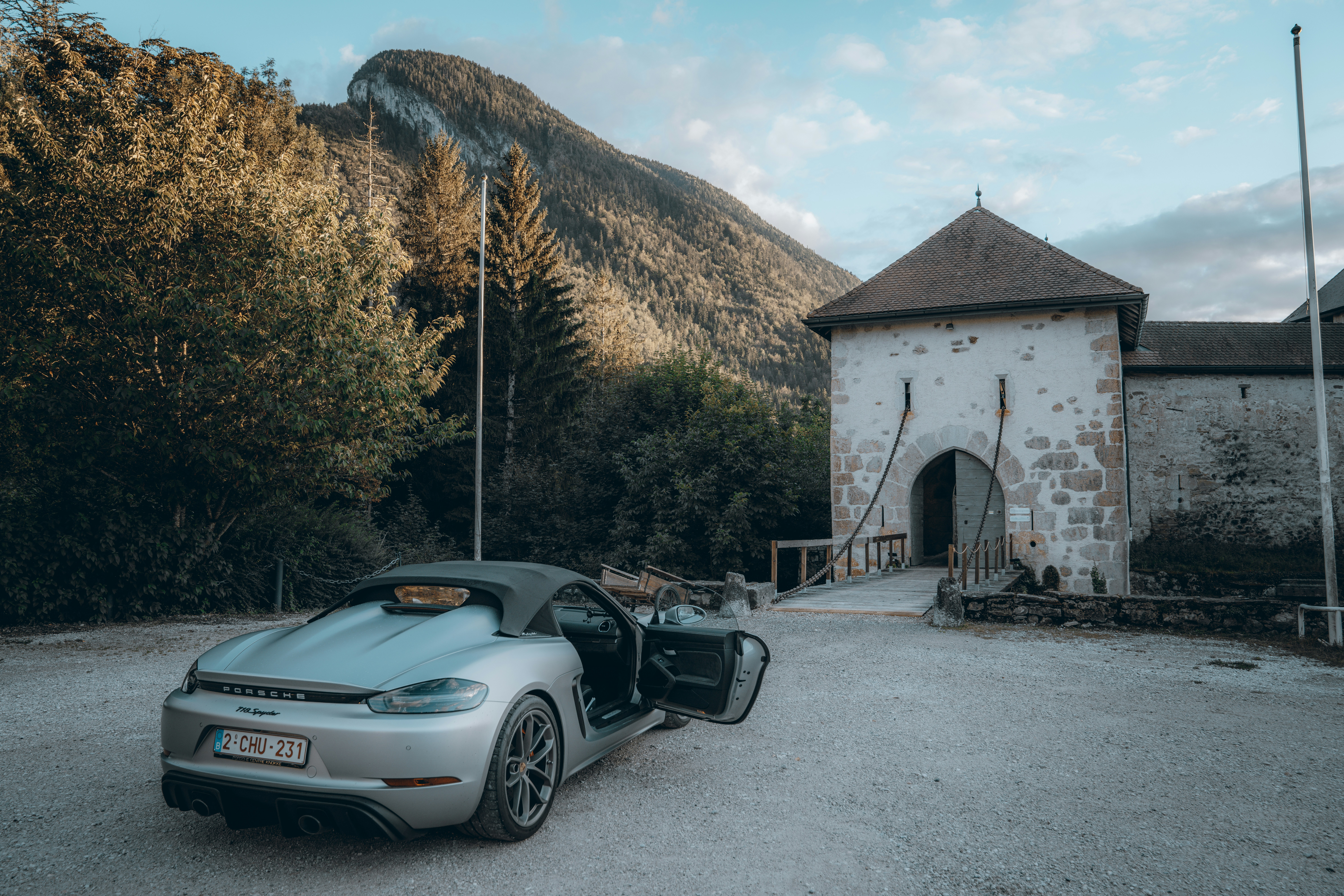 A silver sports car parked in front of a building photo – Free Alps ...