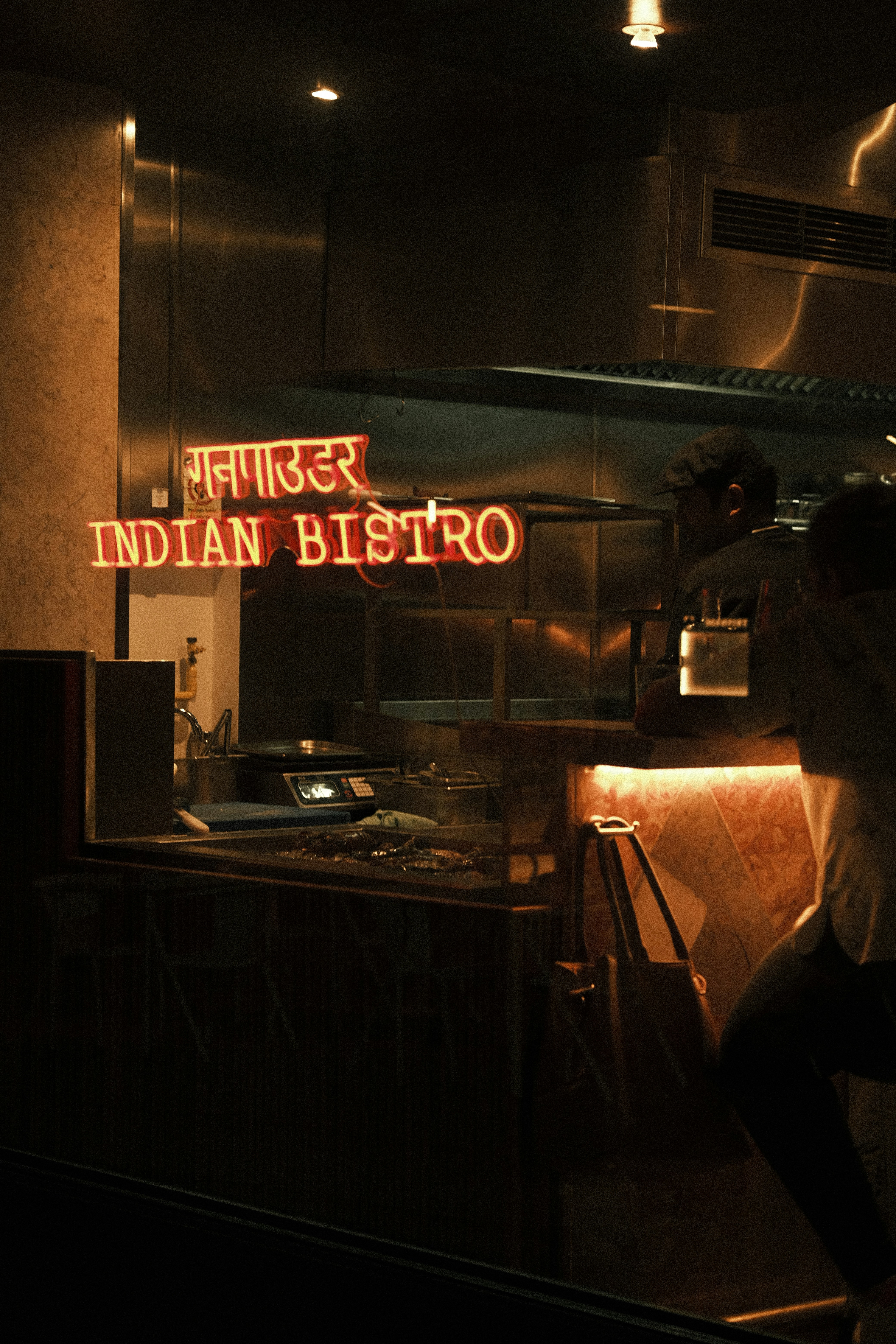 Neon Glow Over a Dim Indian Bistro Kitchen
